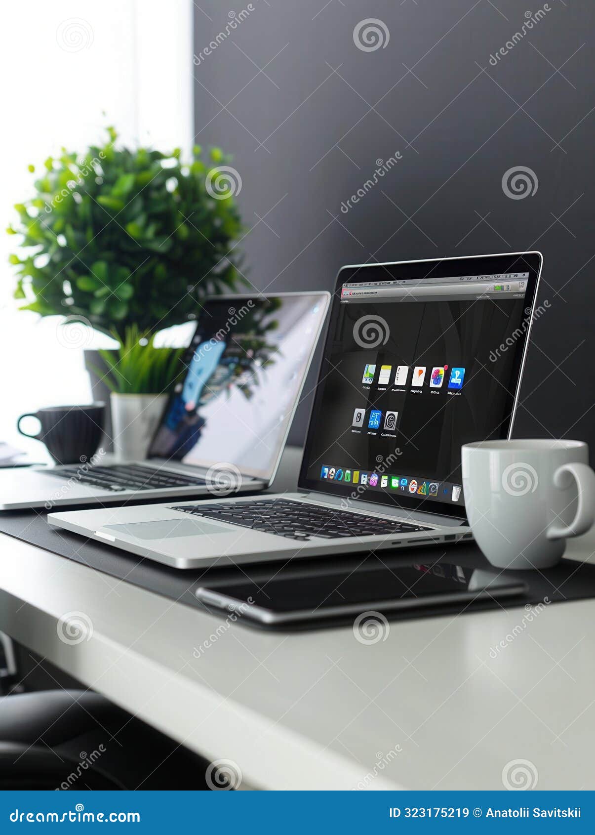 A Modern Workspace Featuring Sleek Laptops and Tablets Displaying ...