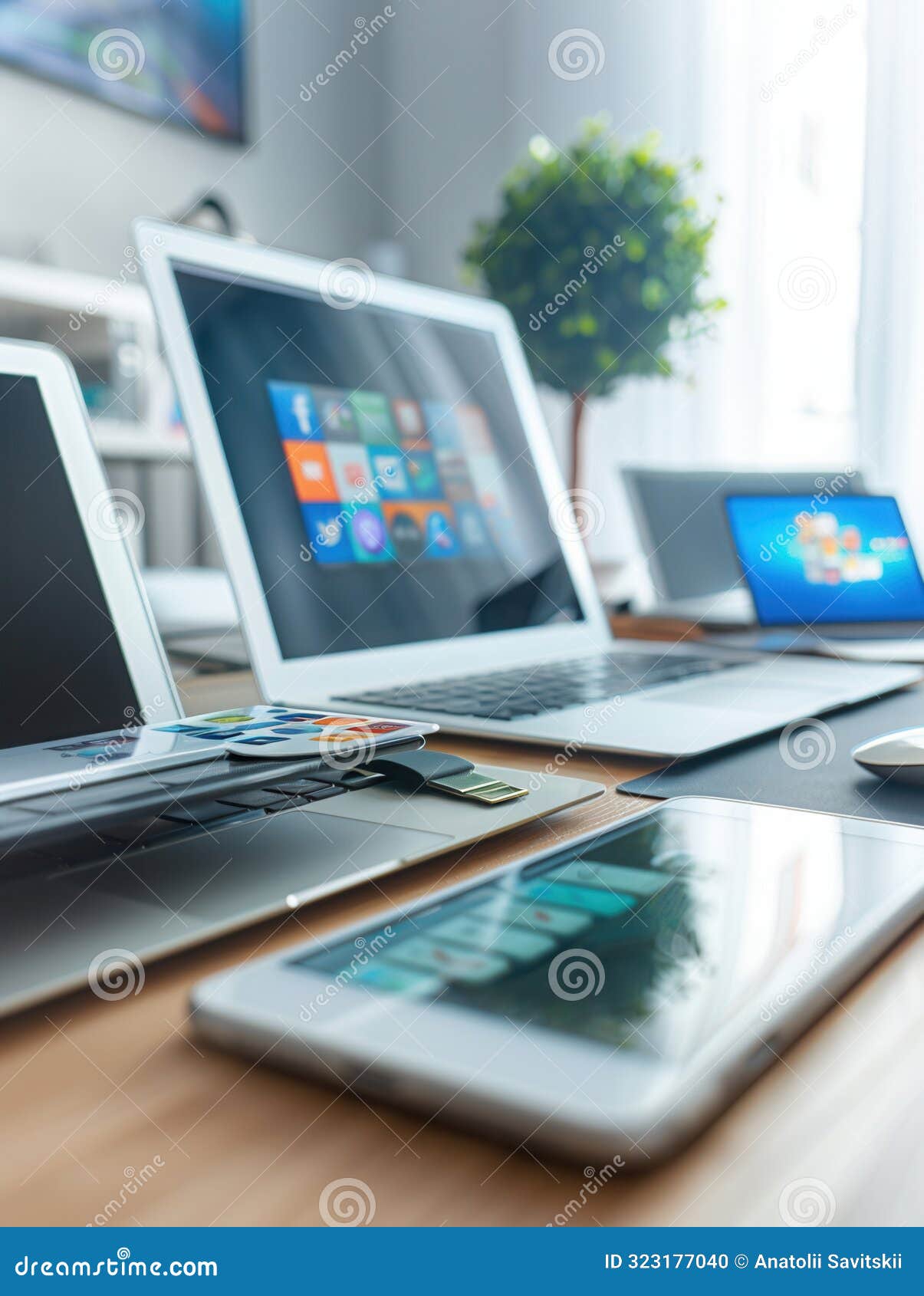 A Modern Workspace Showcasing Several Laptops and Tablets Displaying ...