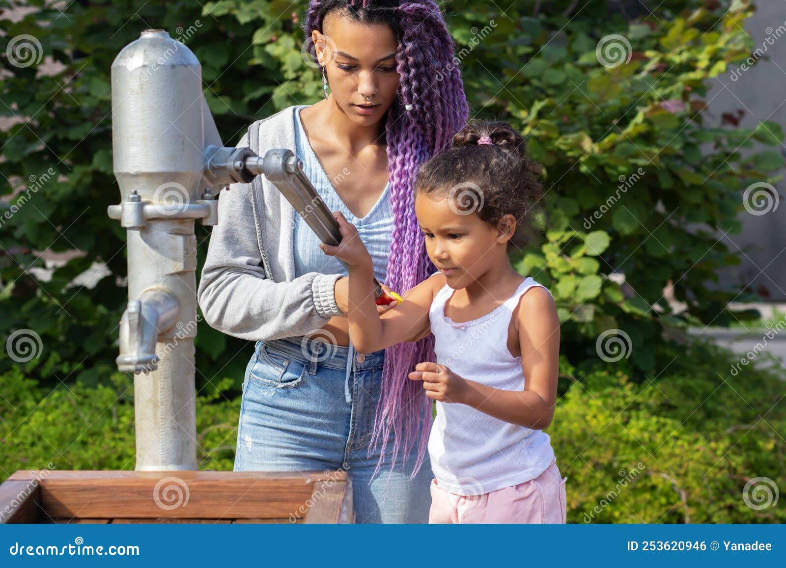 Modern Young Mother with Afro Braids Plays with Her Daughter on the ... Modern Young Mother with Afro Braids Plays with Her Daughter on the ...