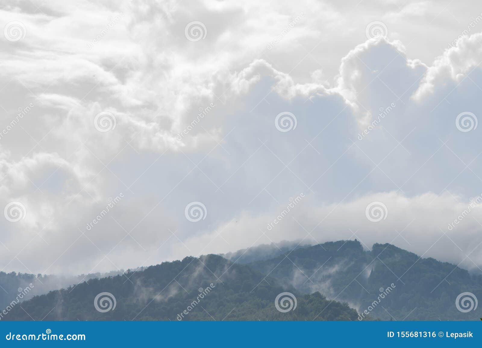 Moisture in the Form of a Pair of Mountains Rising into the Clouds ...