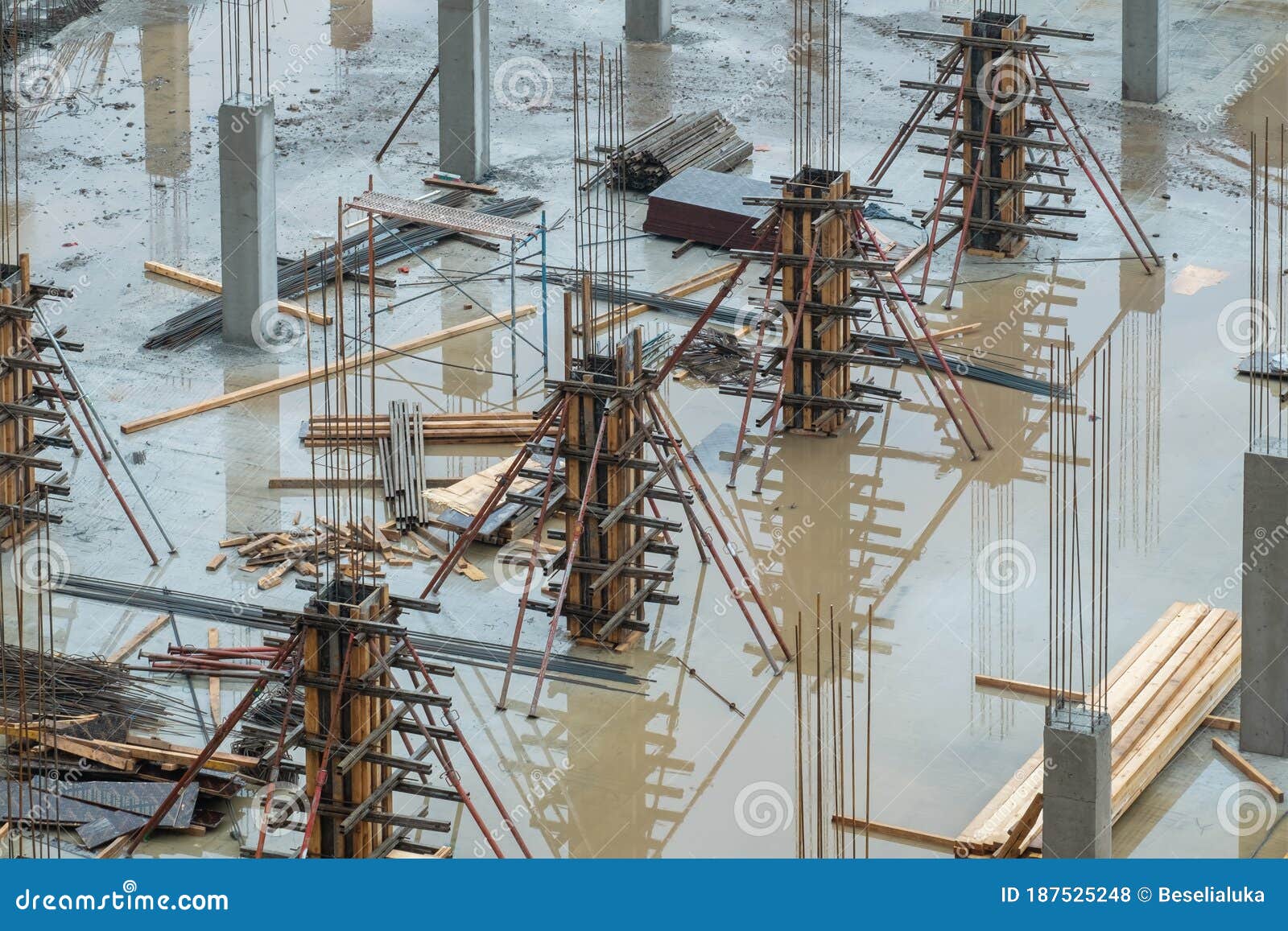 Columns Reflecting on the Puddle at Construction Site Stock Photo ...