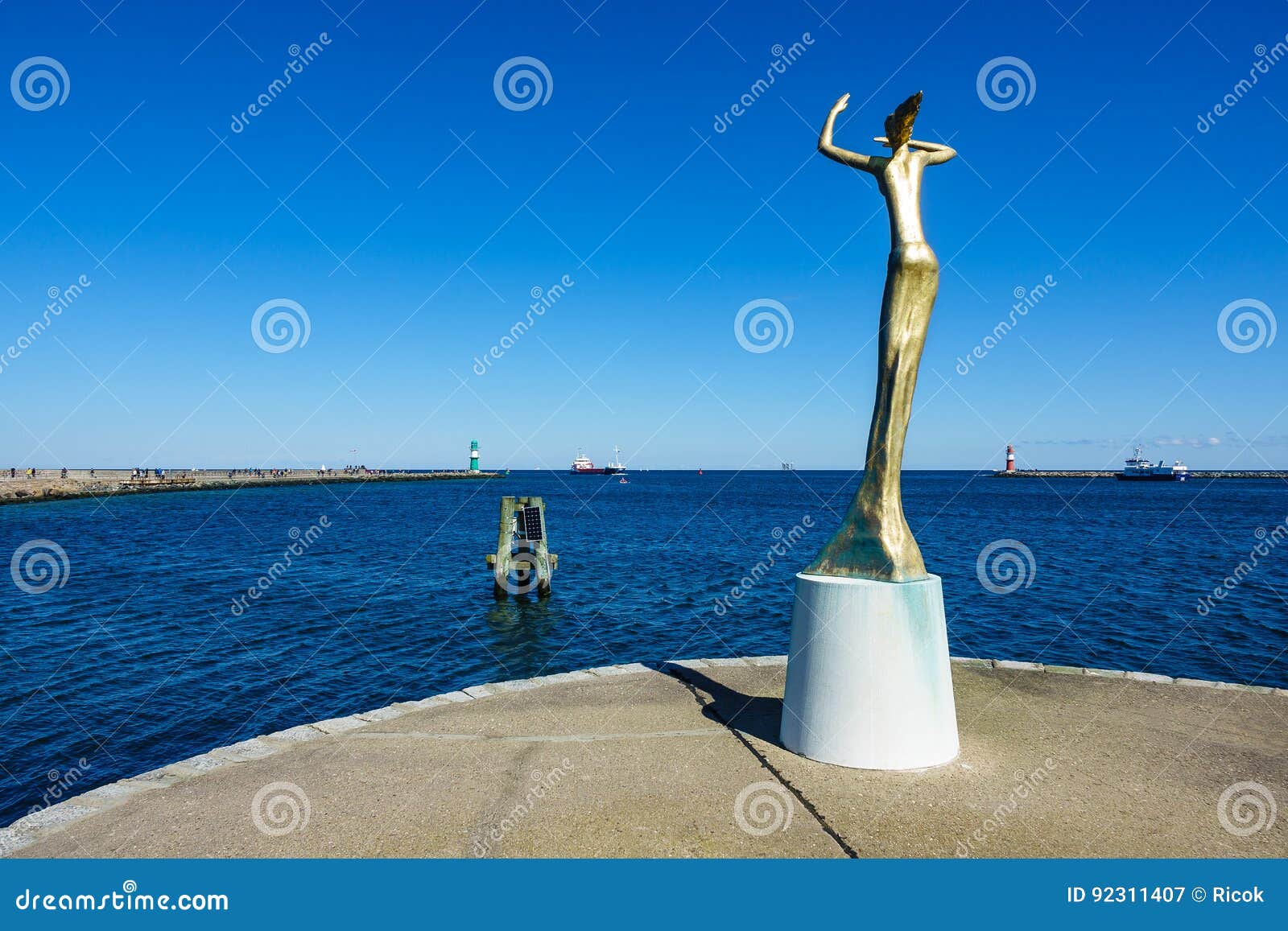 The Mole and a Statue in Warnemuende, Germany Editorial Photography ...