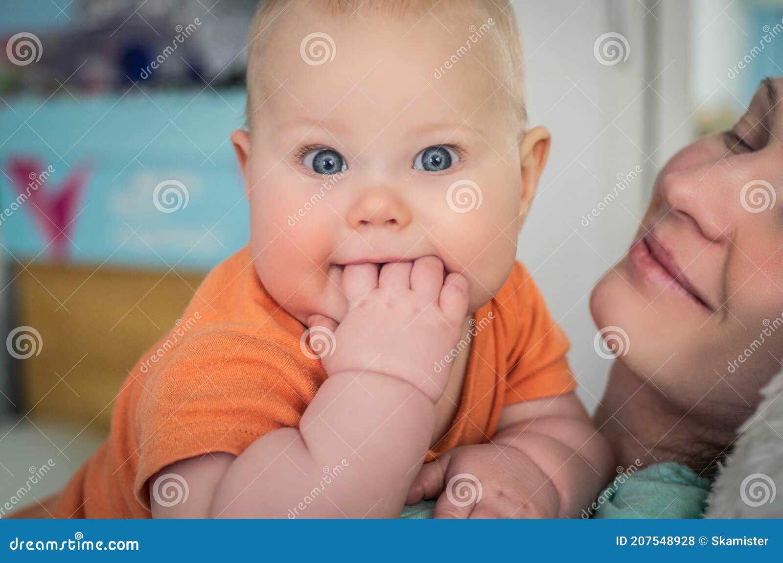 Mom and Baby are Resting and Smiling while Sitting on the Couch Stock ...