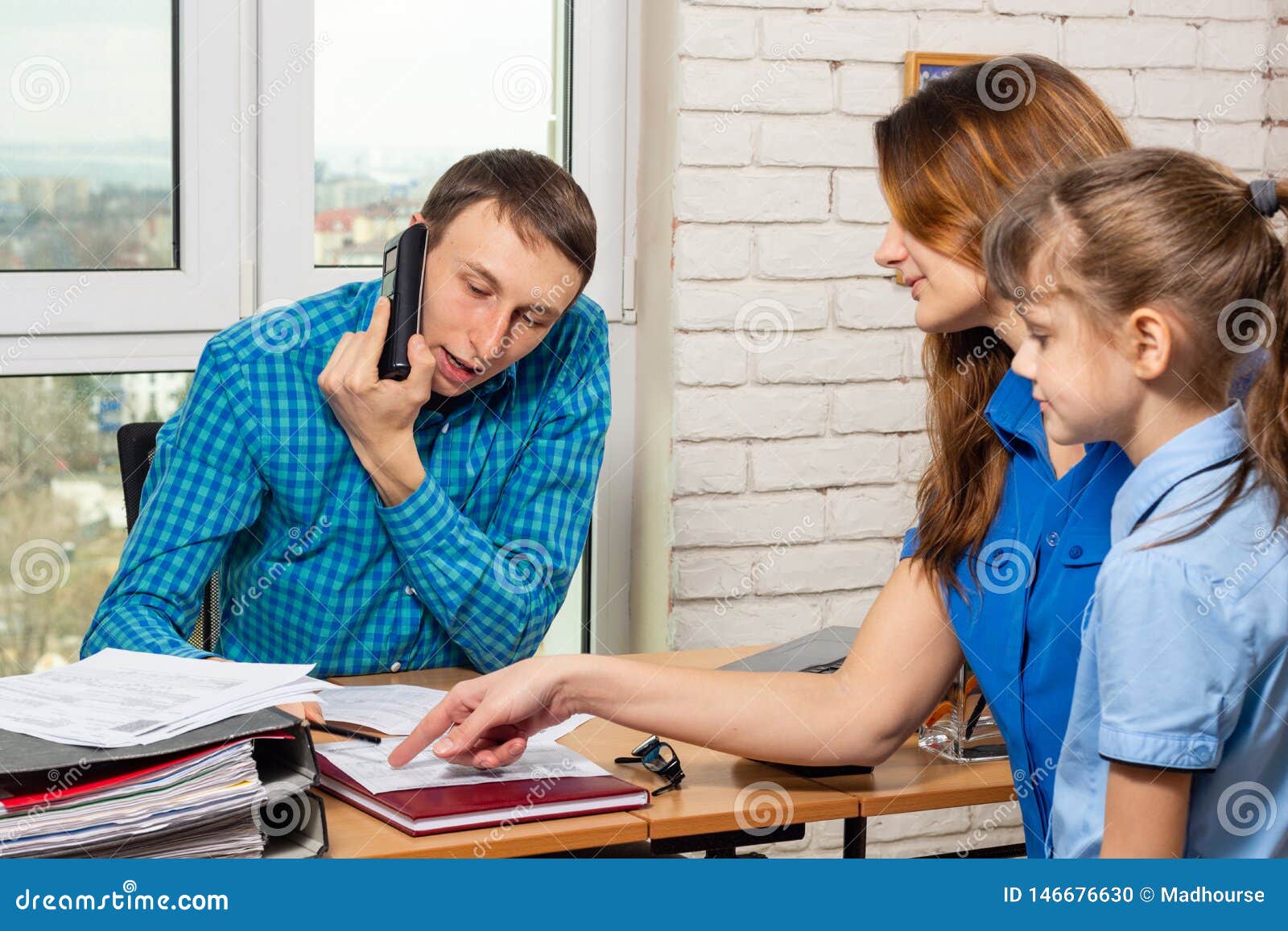 Mom with the Child at the Reception at the Office of the Specialist ...