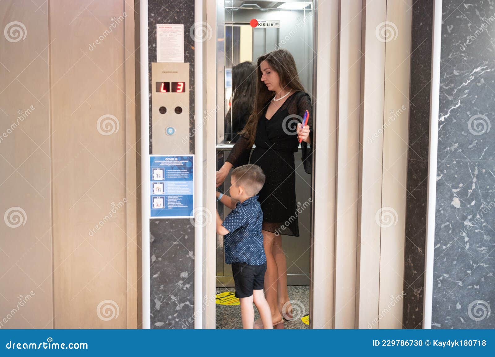 Mom and Child Ride the Elevator Stock Photo - Image of clothing ...