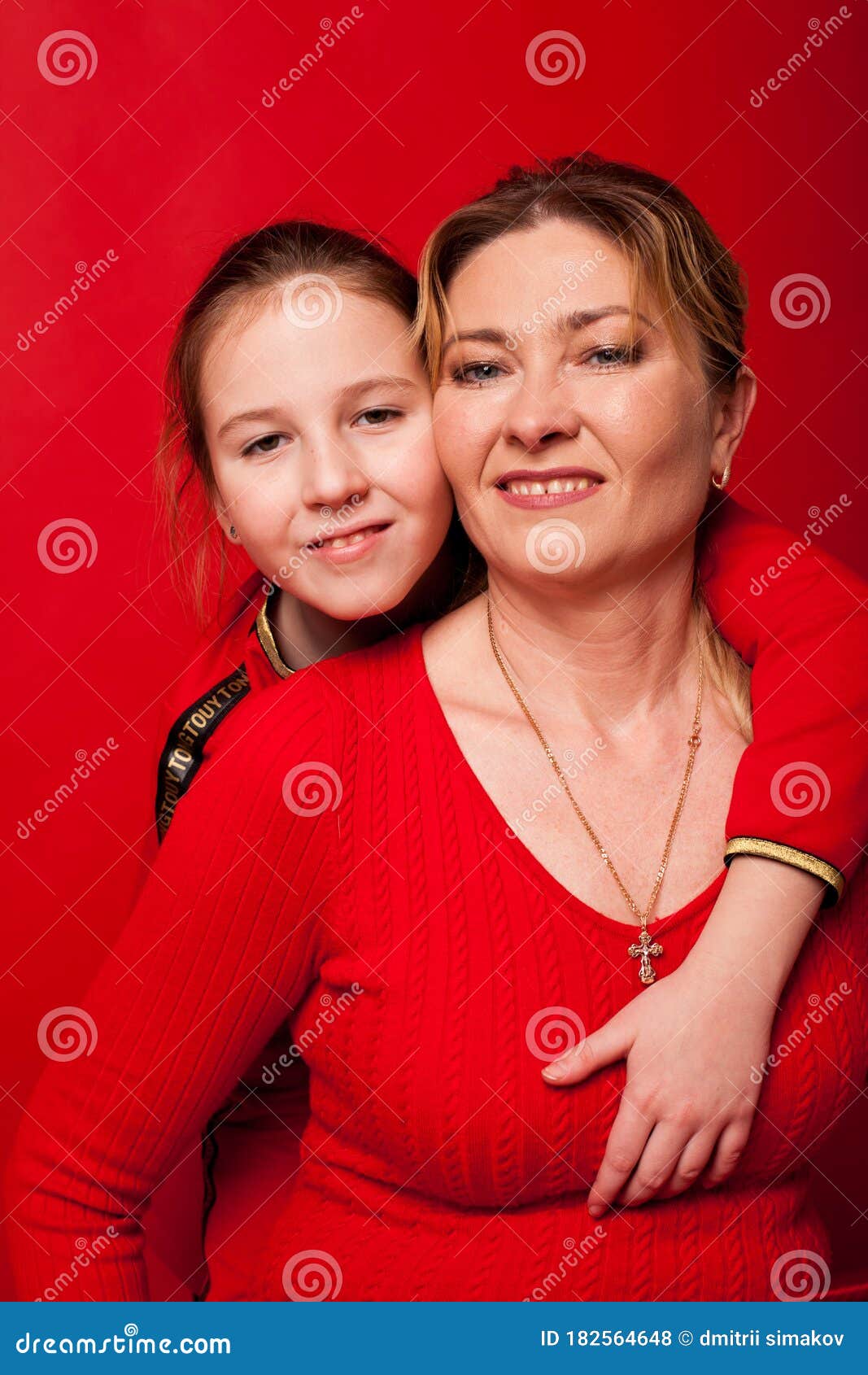 Mom and Daughter Lovingly Cuddle on a Red Background Stock Photo ...