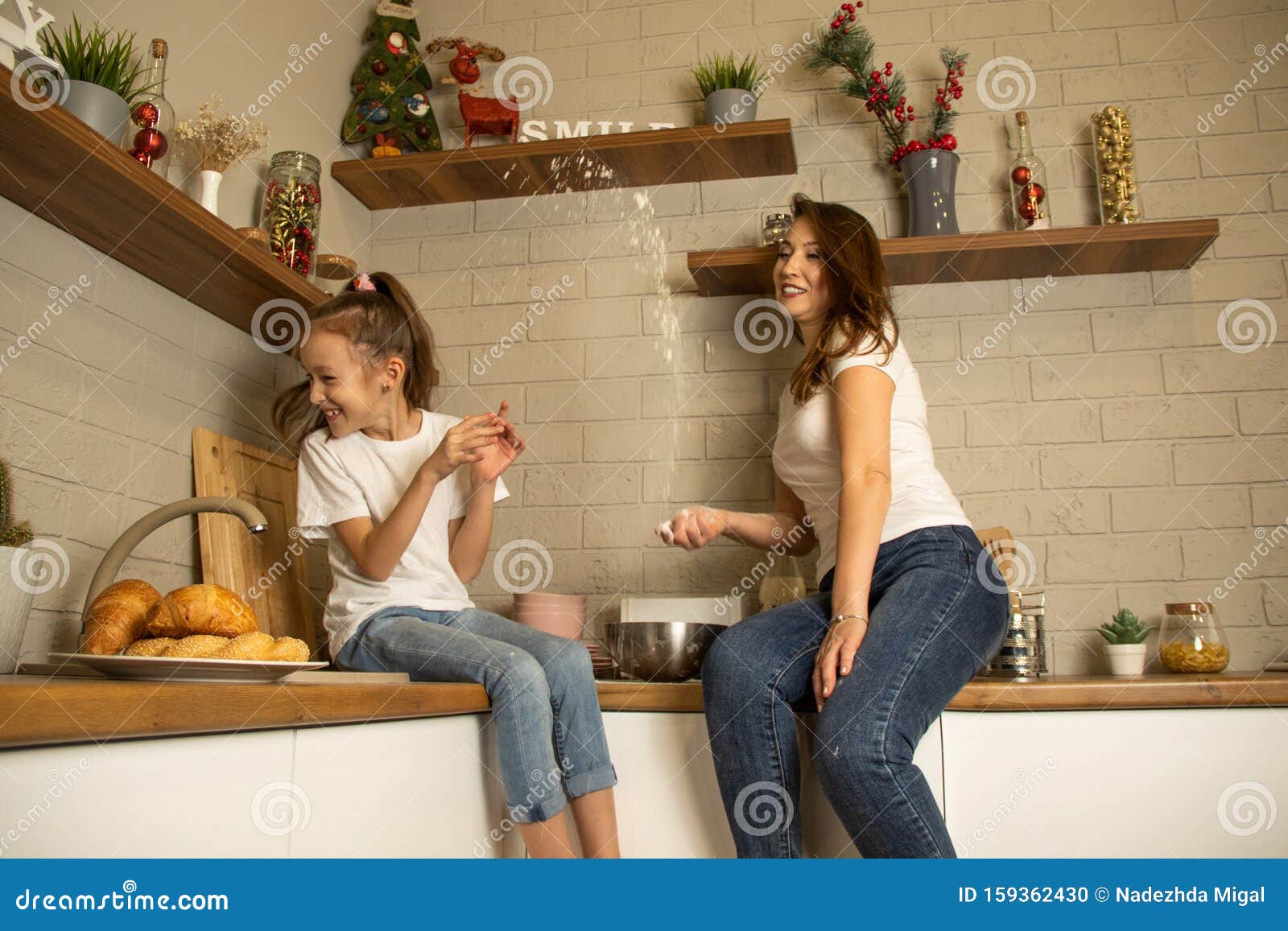 Mom And Daughter Are Playing In The Kitchen Messing With Flour Stock