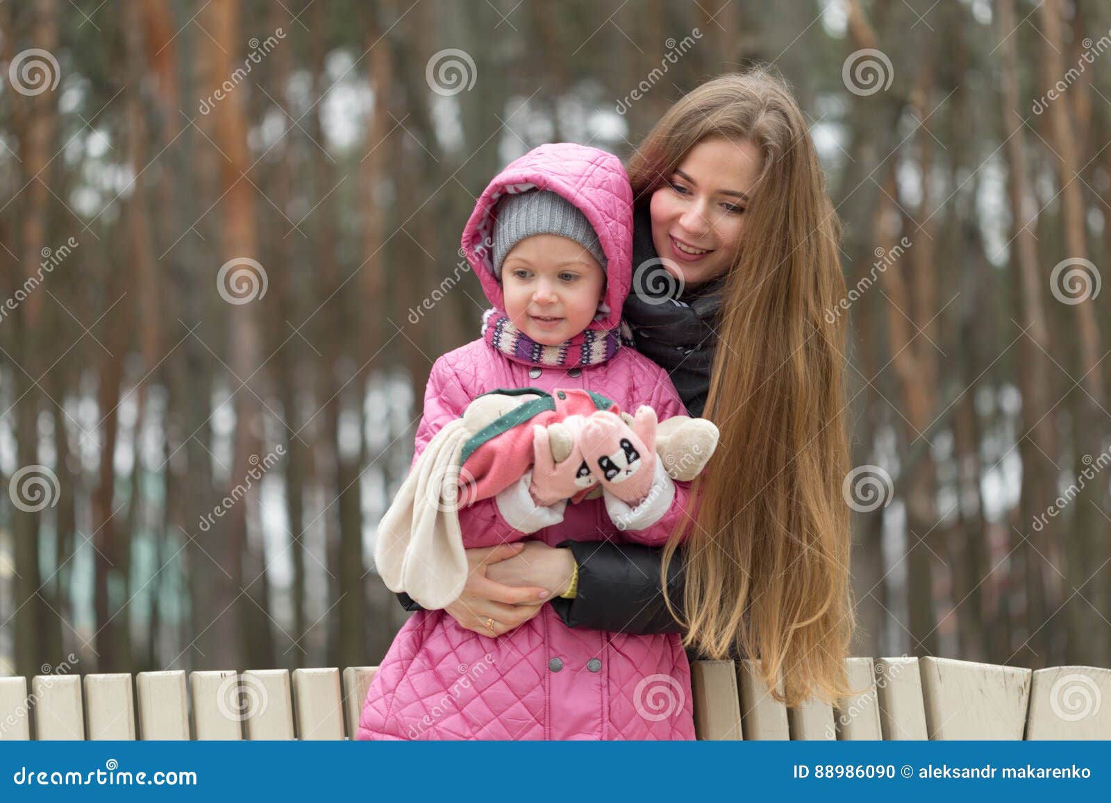 Mom and Daughter are Sitting on a Park Bench Stock Photo - Image of ...