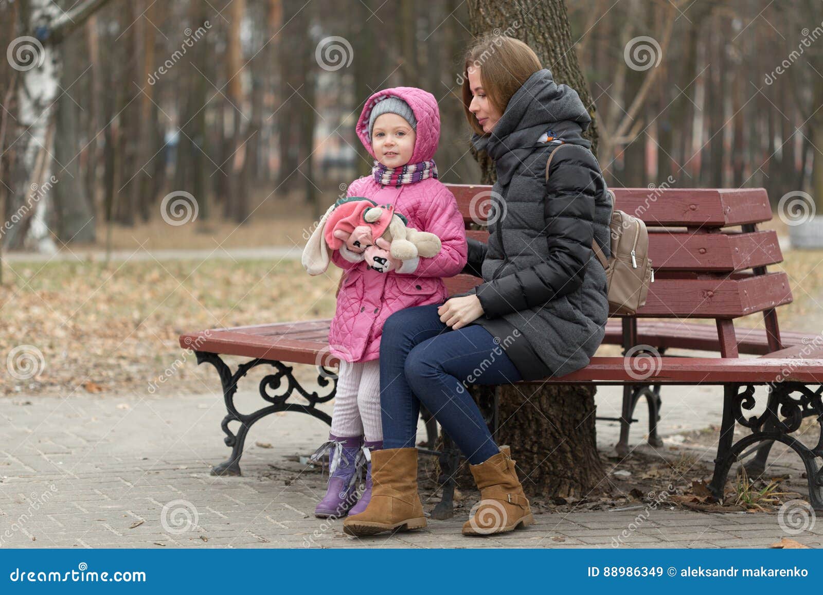 Mom and Daughter are Sitting on a Park Bench Stock Image - Image of ...