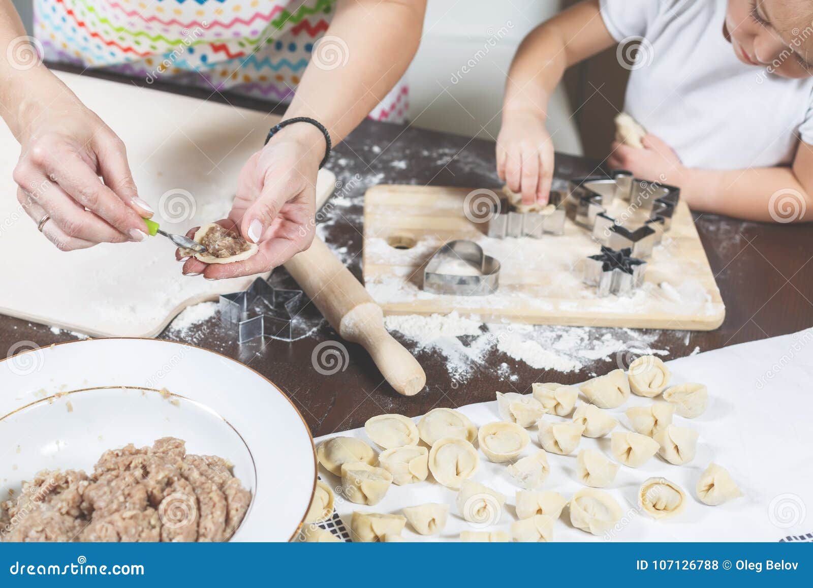 Mom and Daughter Together Make Dumplings in the Kitchen at Home Stock ...