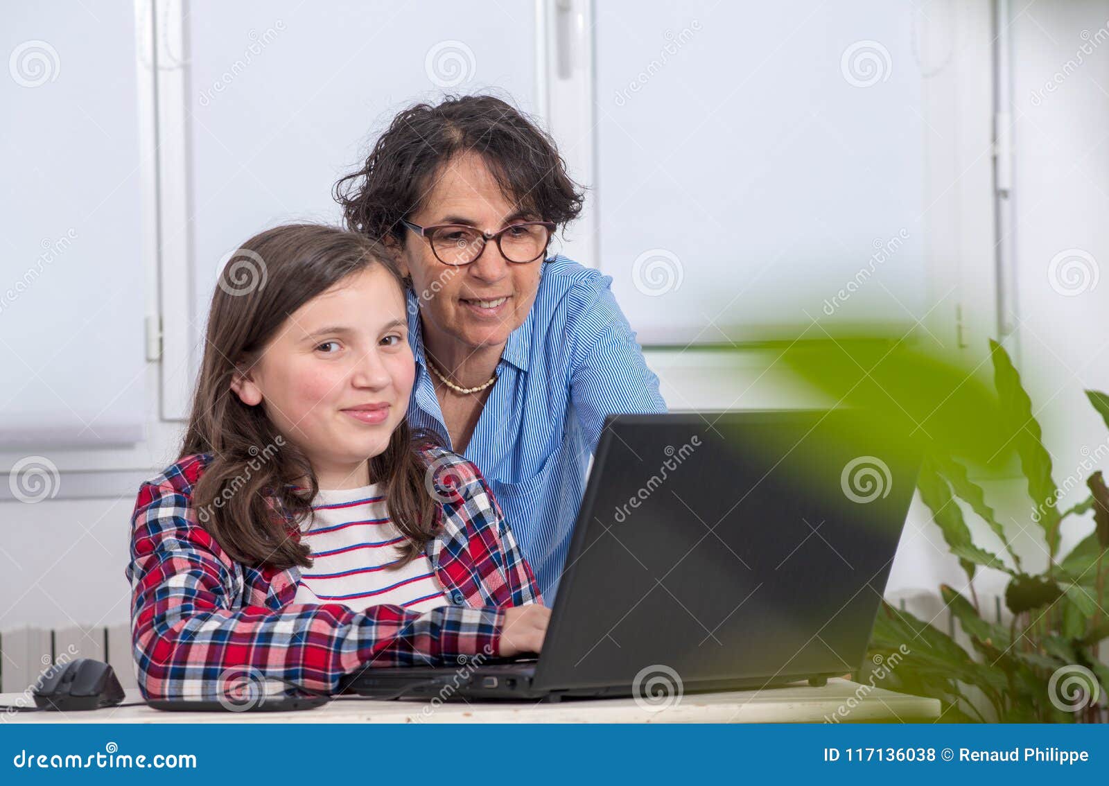 Mom and Daughter Using a Laptop at Home Stock Photo - Image of indoors ...