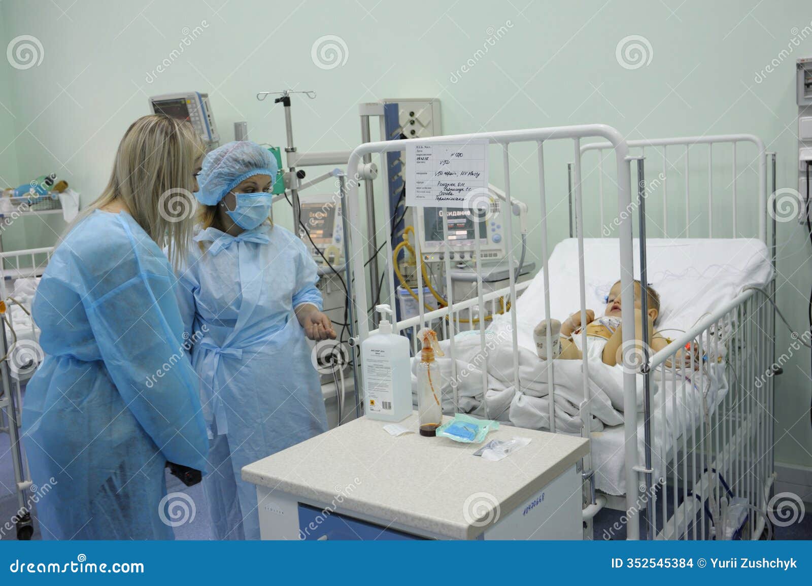 Mom and Doctor Communicating Standing by Baby Patient Lying on a ... Mom and Doctor Communicating Standing by Baby Patient Lying on a ...