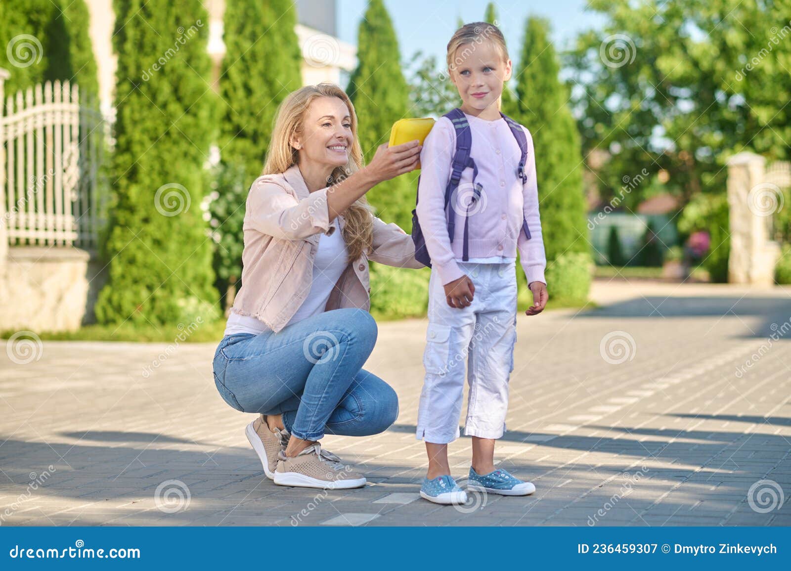 Mom Fixing a Backpack on Her Kids Back Stock Image - Image of backpack ...