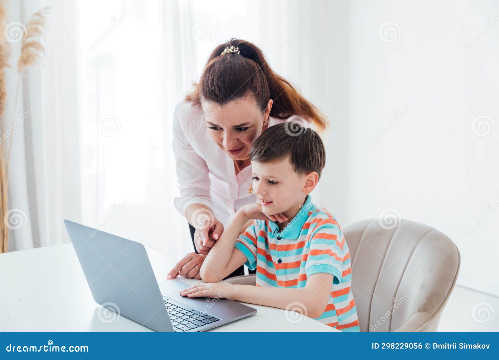 Mom Helps Her Son Do School Assignment on the Computer Stock Photo ...