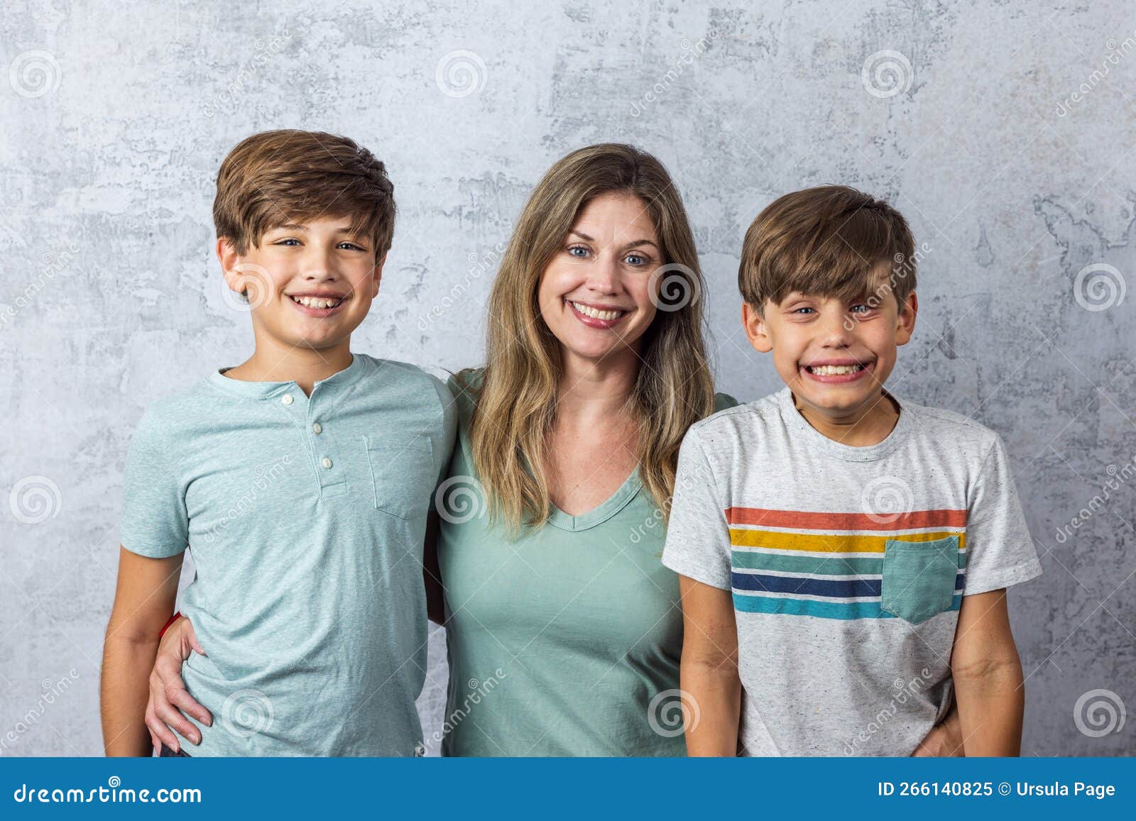 A Mom and Her Two Young and Tween Boys in a Studio Setting on a White ...