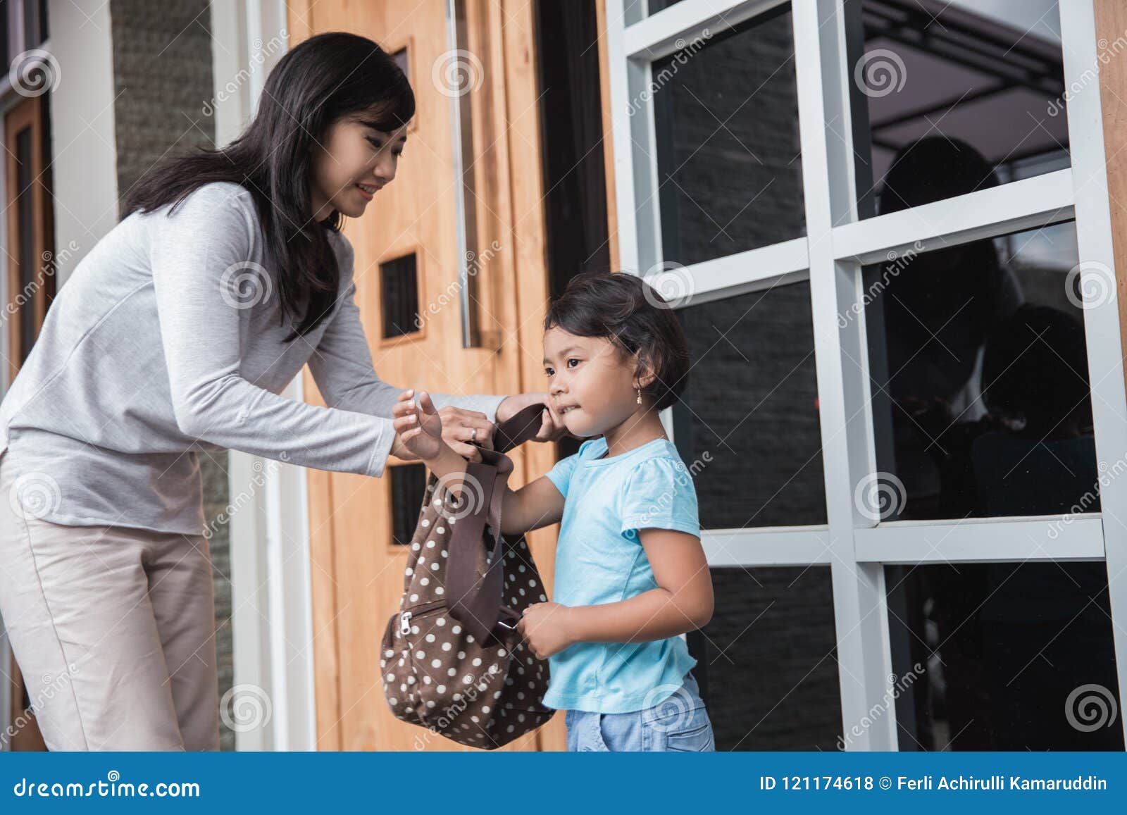 Mom Put Backpack on Her Daughter Stock Photo - Image of morning, home ...