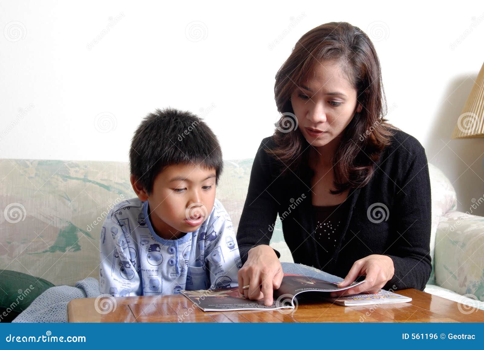 Mom reading with son stock photo. Image of legs, book, person - 561196