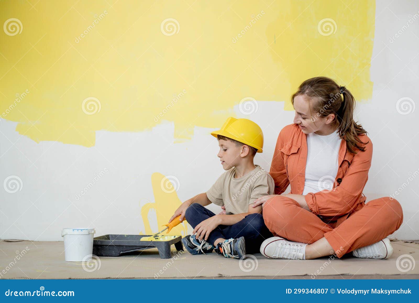 Mom and Son with Rollers Near a Yellow Wall. Repairs Stock Image ...