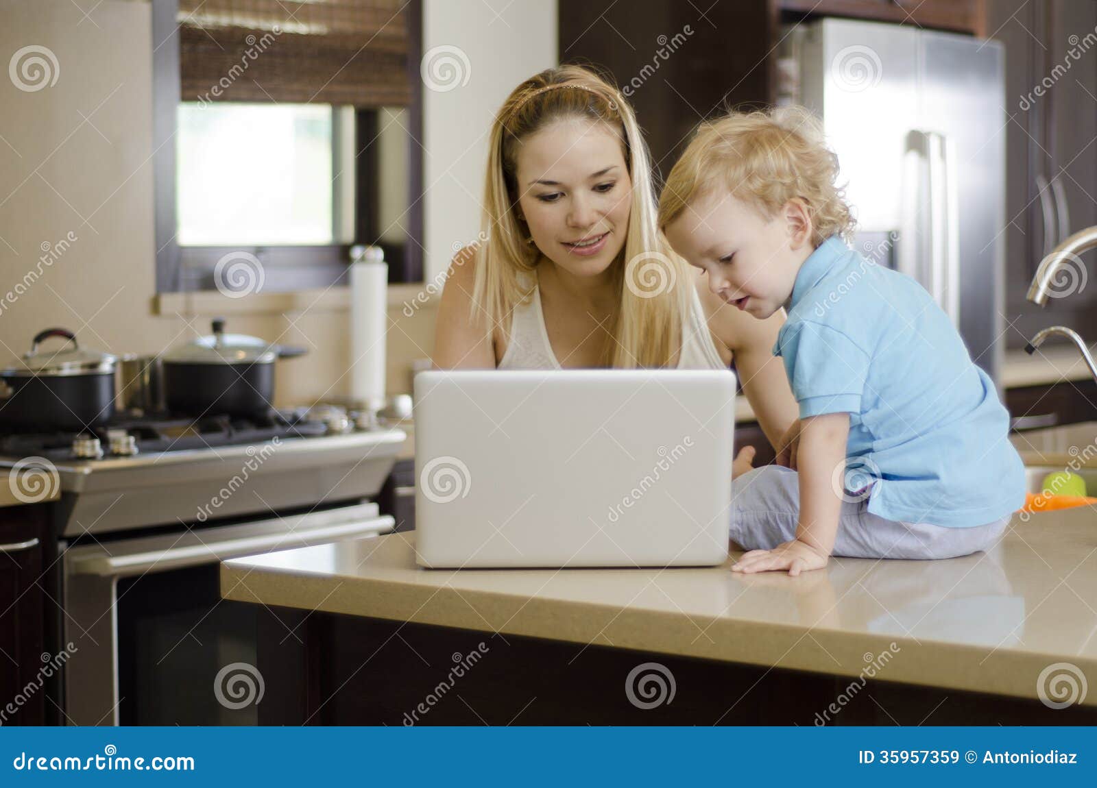 Mom and son using a laptop stock image. Image of care - 35957359