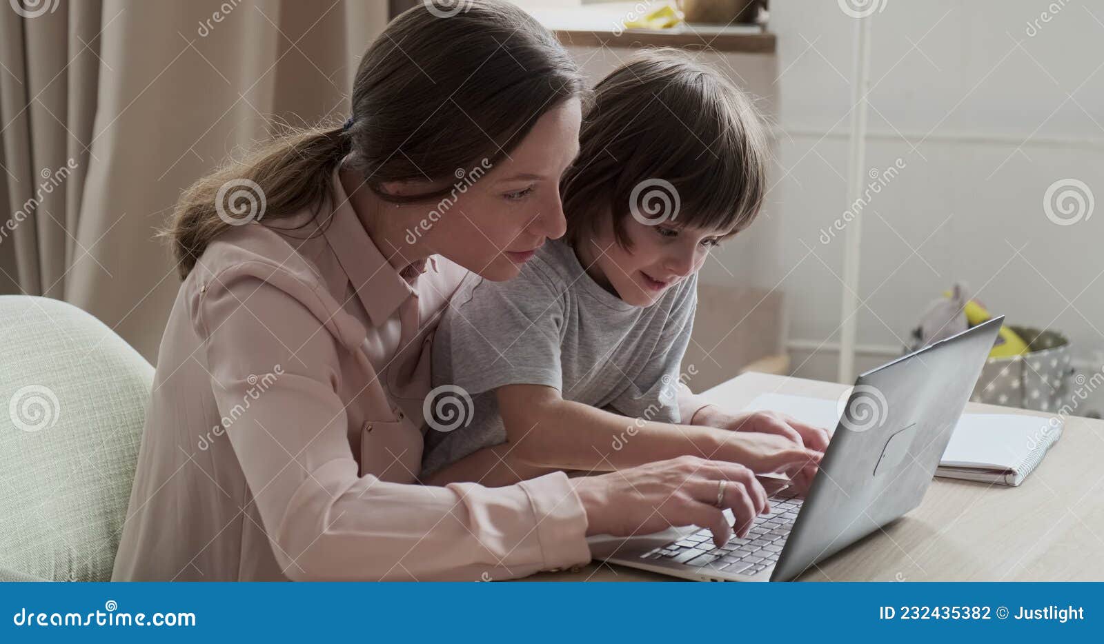 Mom and Son are Working on the Computer Together, Learning Programming ...