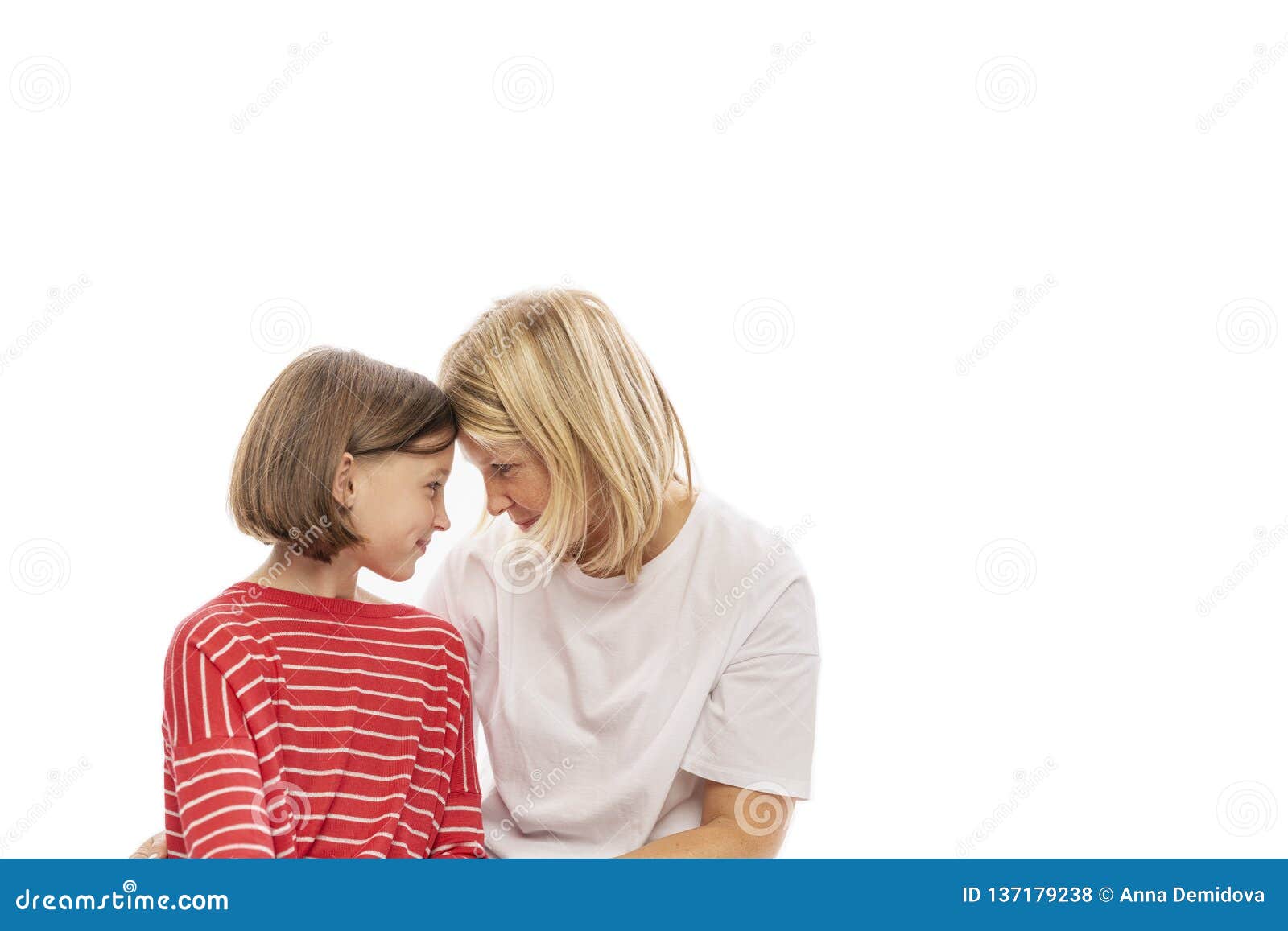 Mom And Teen Daughter Smiling And Hugging Isolated On White Background
