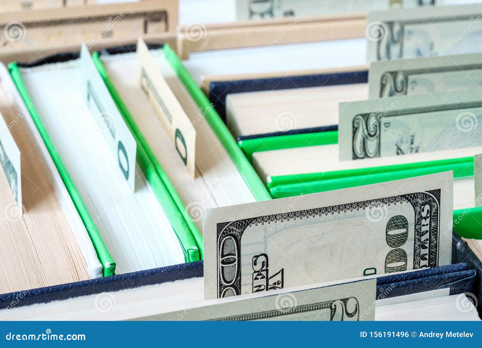 Money is Inserted on Top of the Books Standing in the Ranks Stock Photo ...