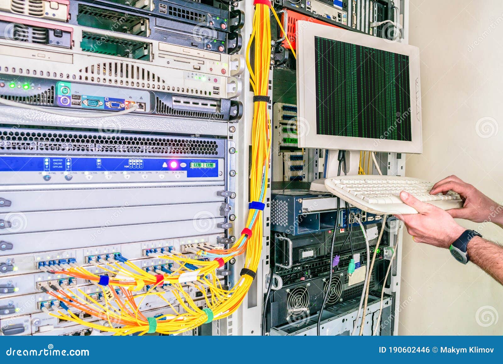 The Monitor And Keyboard Are In The Server Room. Male Hands On The ...