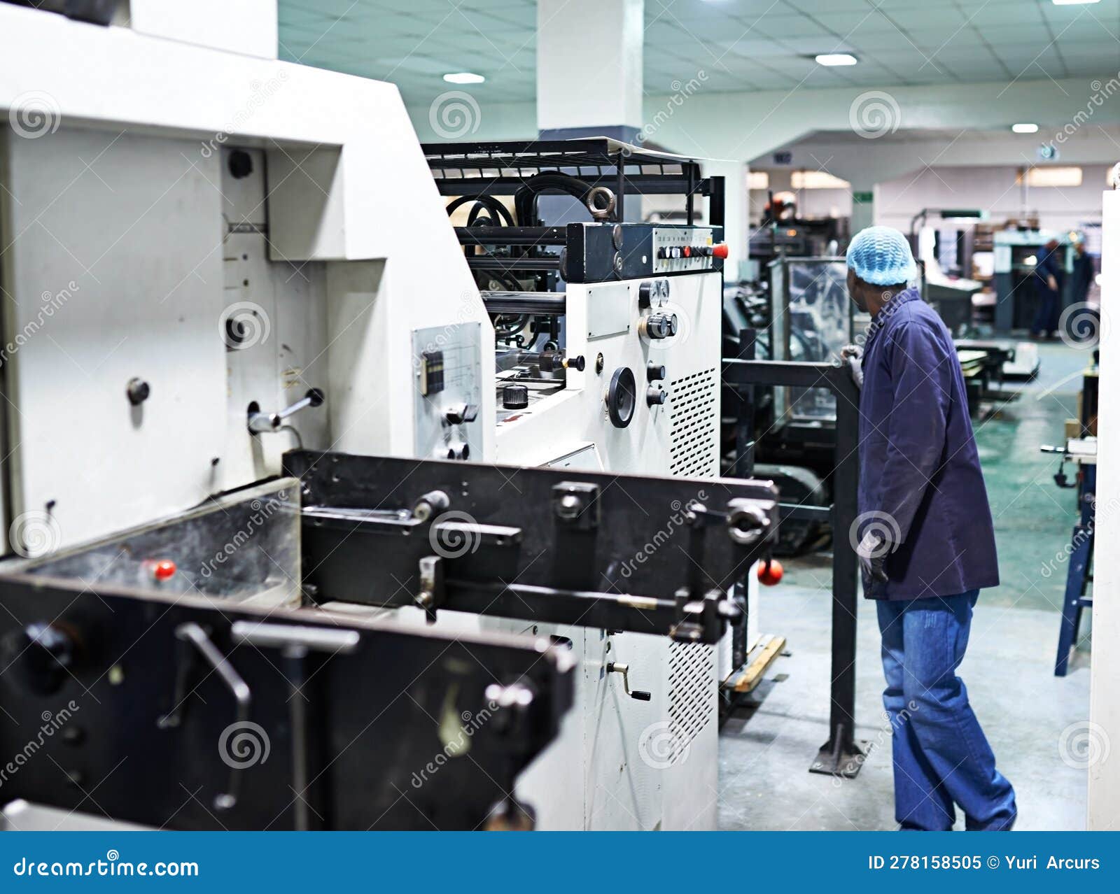 Monitoring Every Step of the Way. a People Working Inside a Printing ...