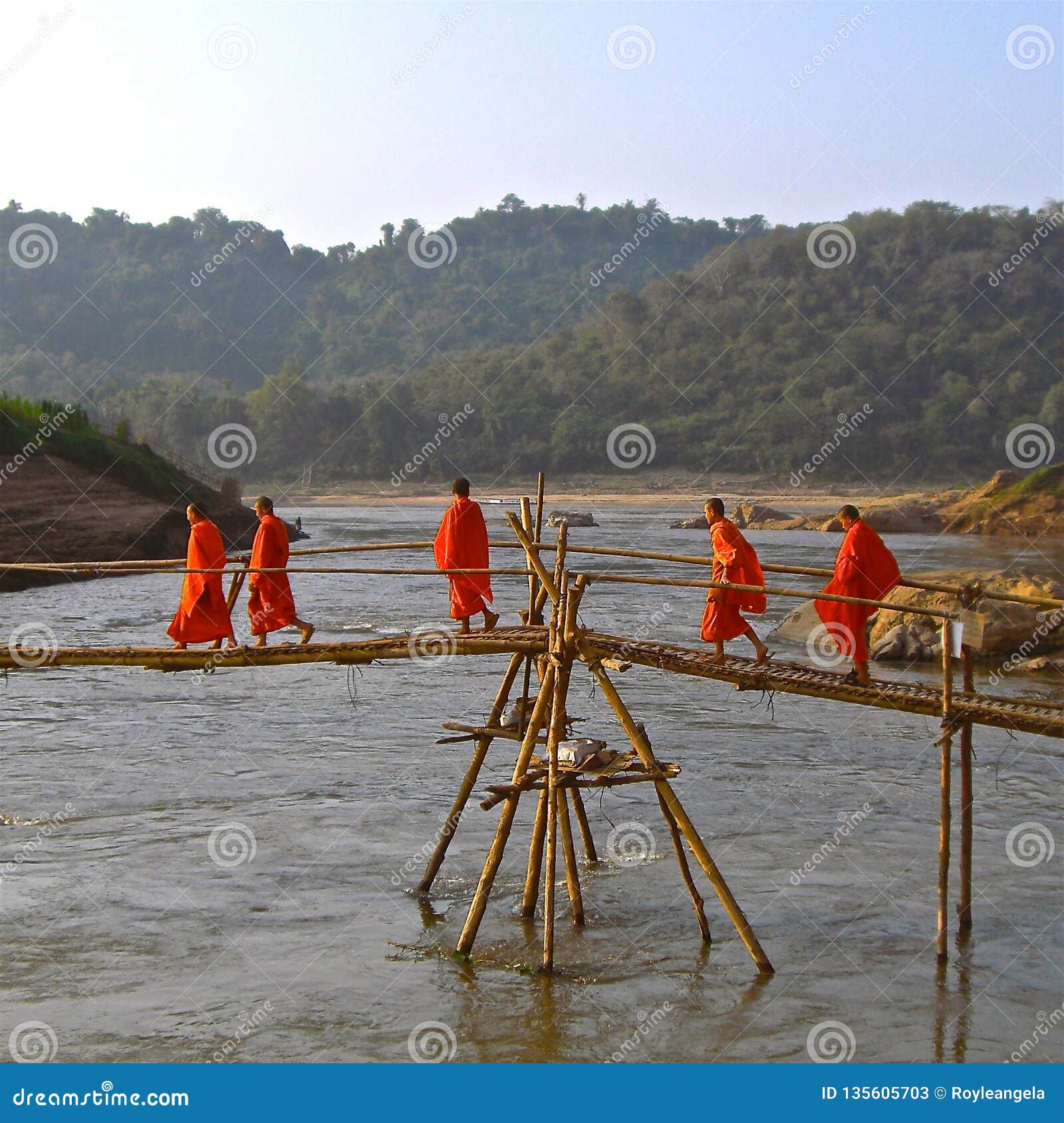 Monks on a rustic bridge editorial stock photo. Image of bamboo - 135605703