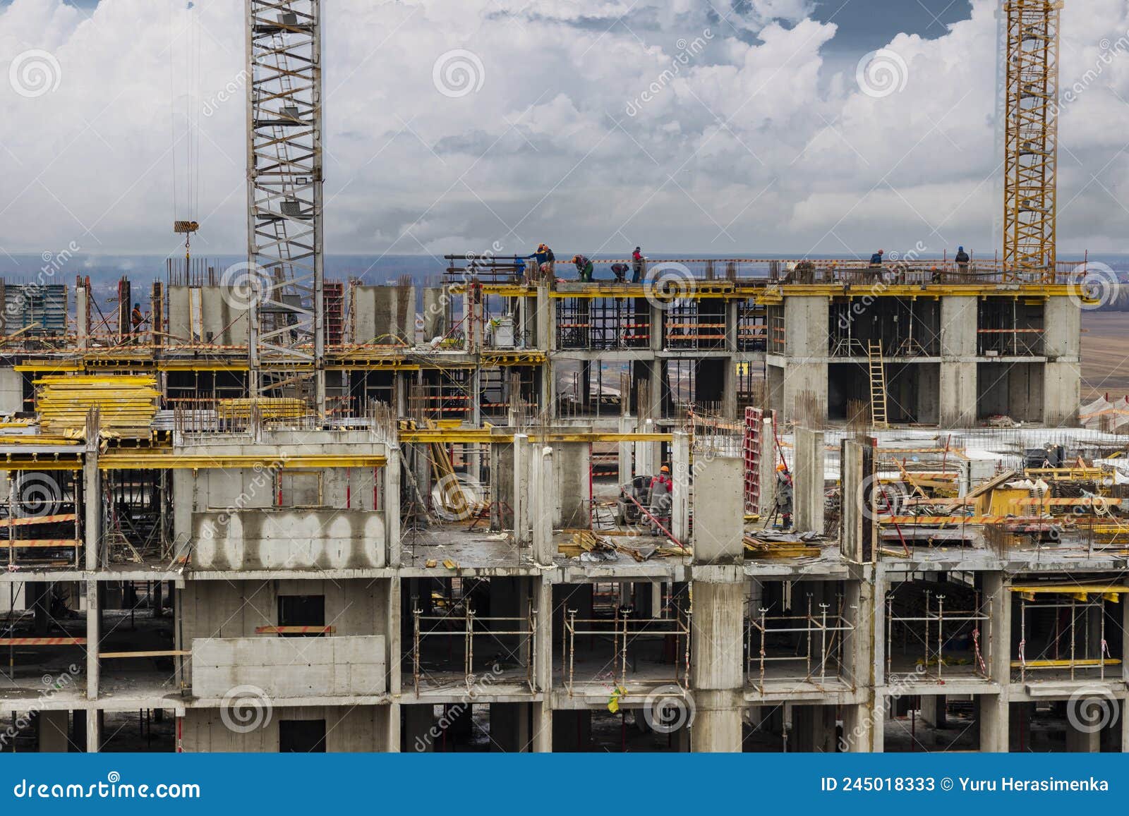 Monolithic Frame Construction of the Building. Workers Working at the ...