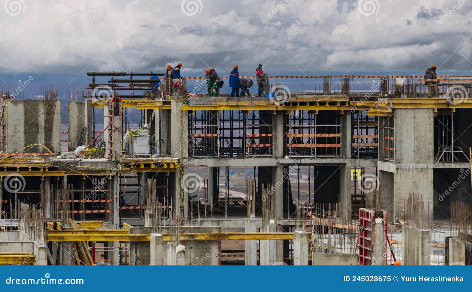 Monolithic Frame Construction of the Building. Workers Working at the ...
