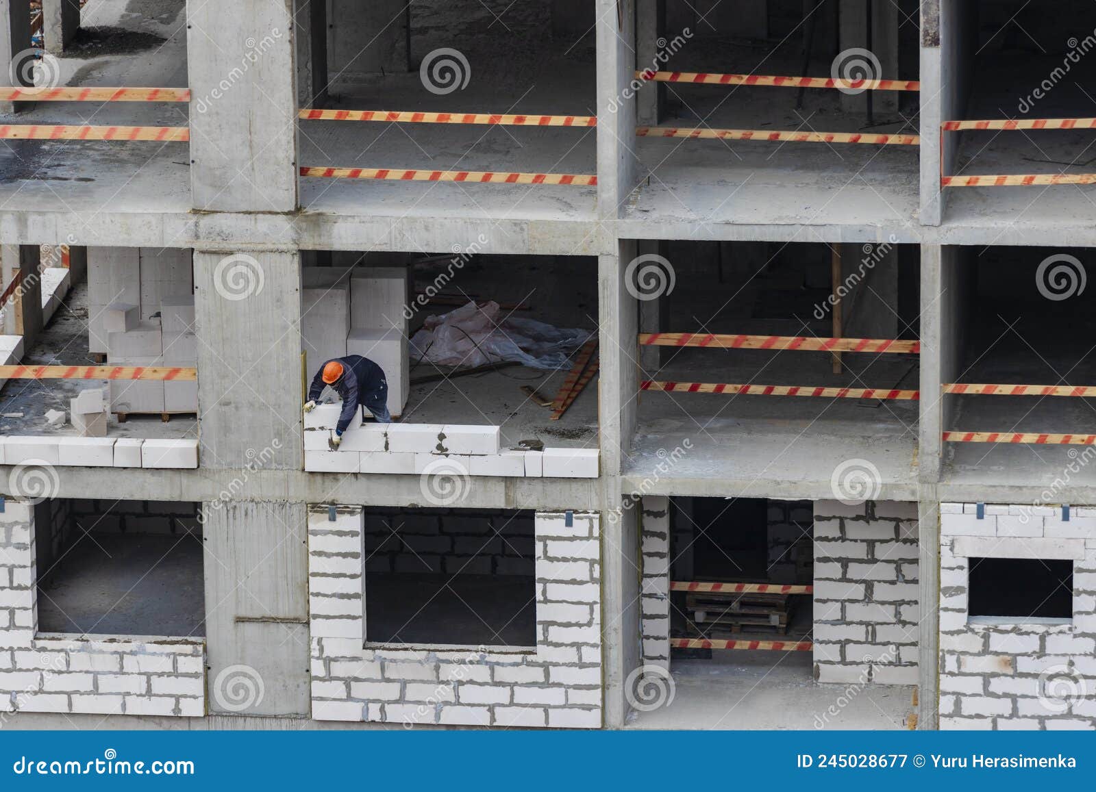 Monolithic Frame Construction of the Building. Workers Working at the ...