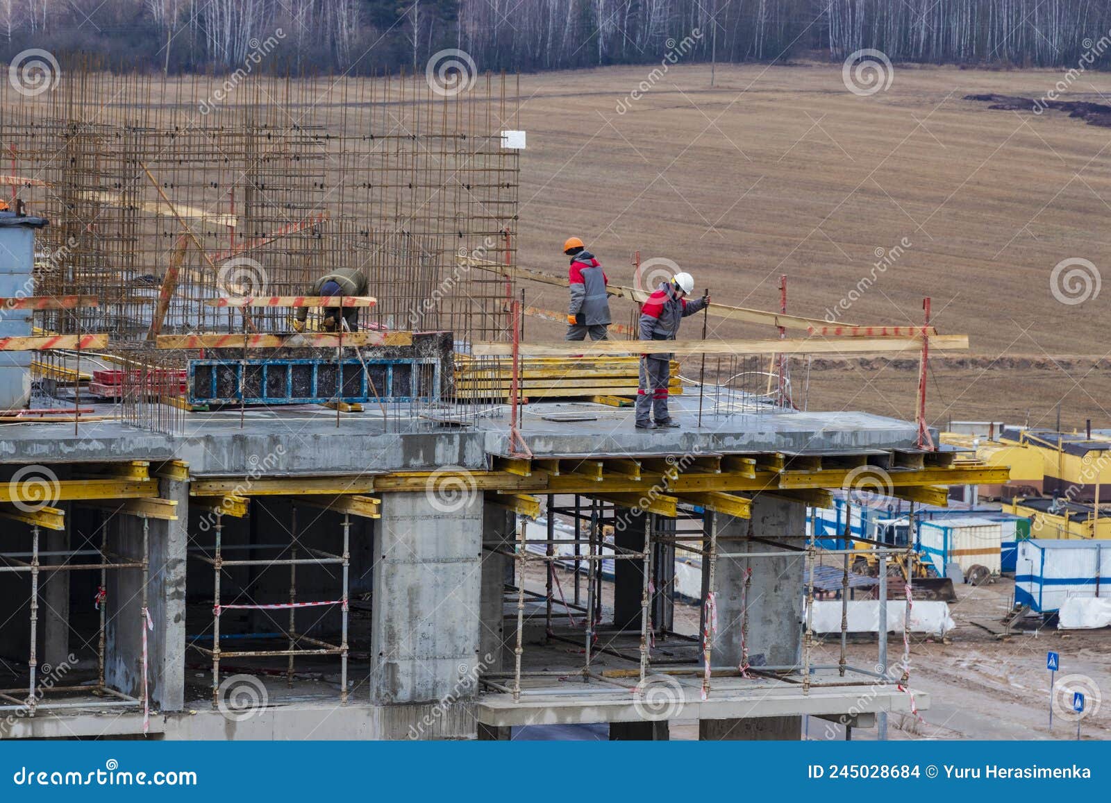 Monolithic Frame Construction of the Building. Workers Working at the ...