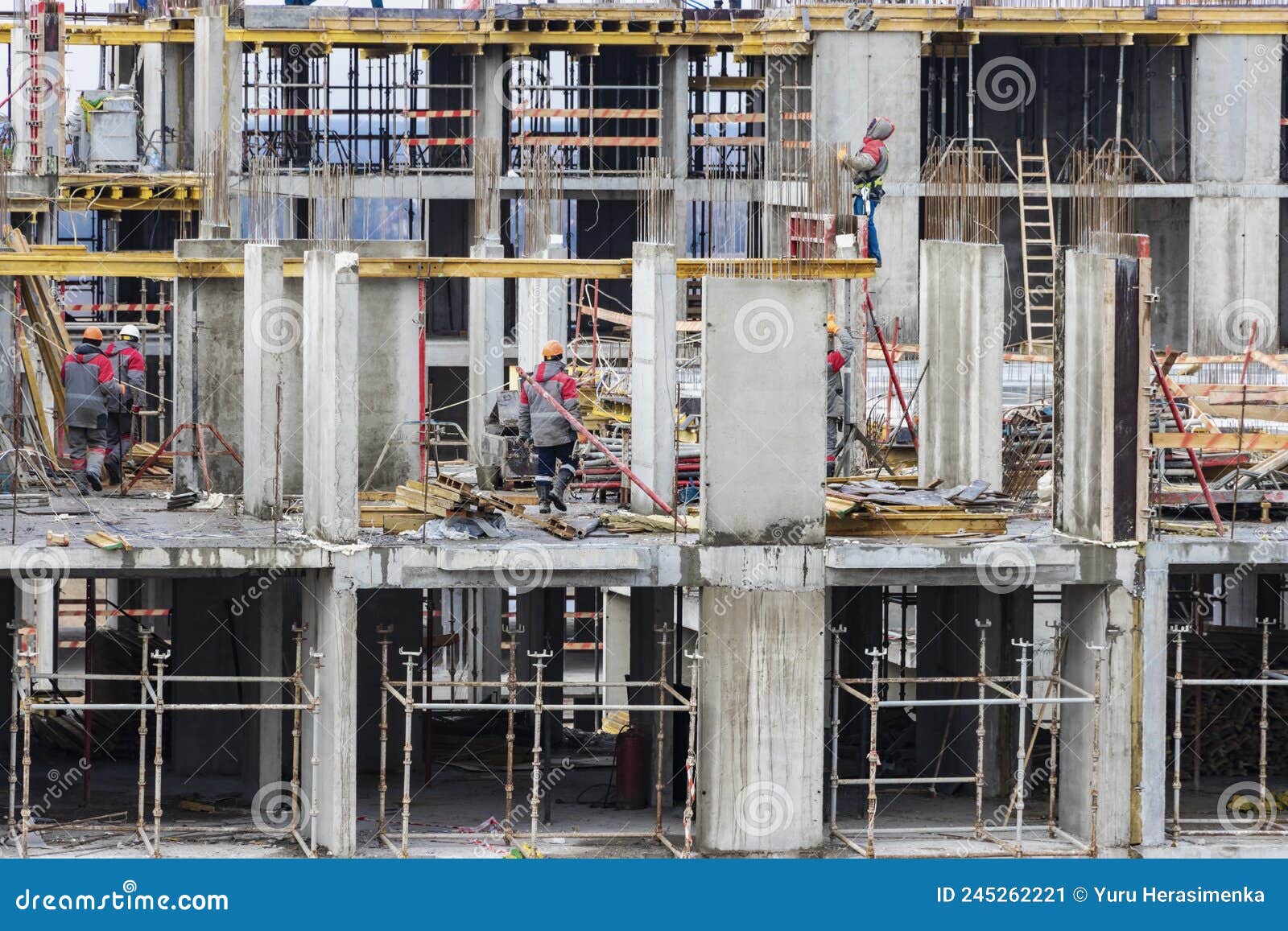 Monolithic Frame Construction of the Building. Workers Working at the ...