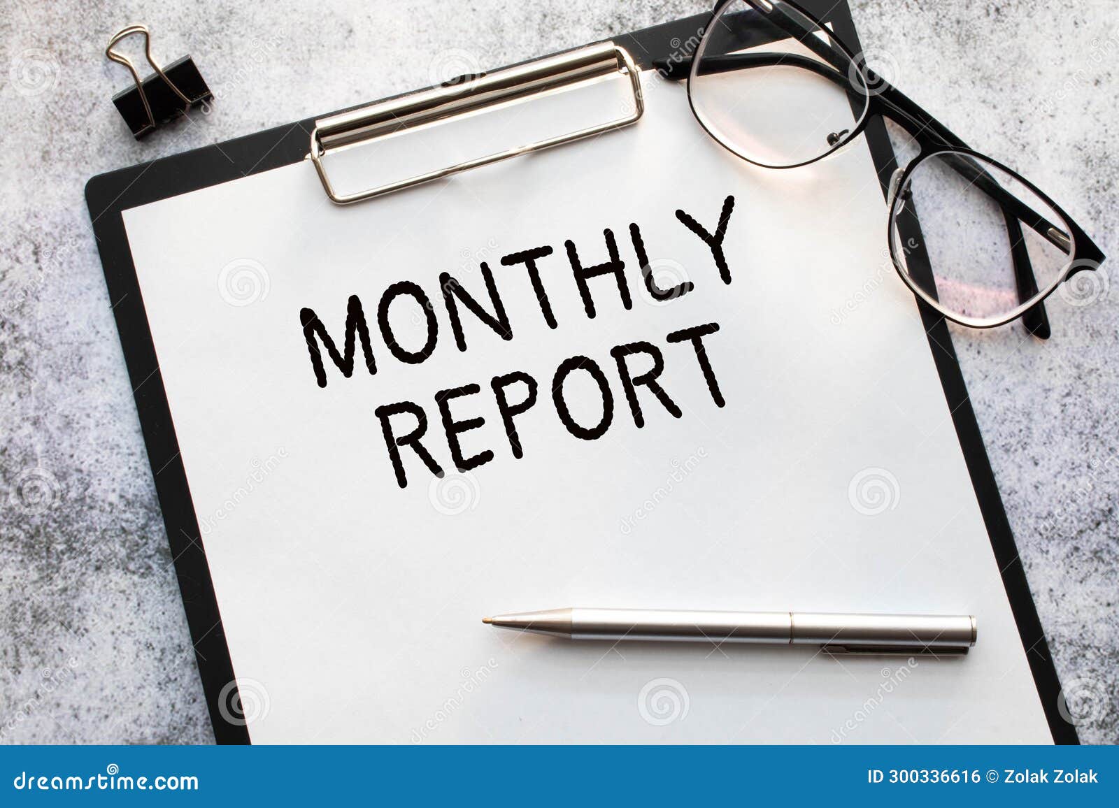 MONTHLY REPORT Text Written on a Paper Clipboard with Chart and ...
