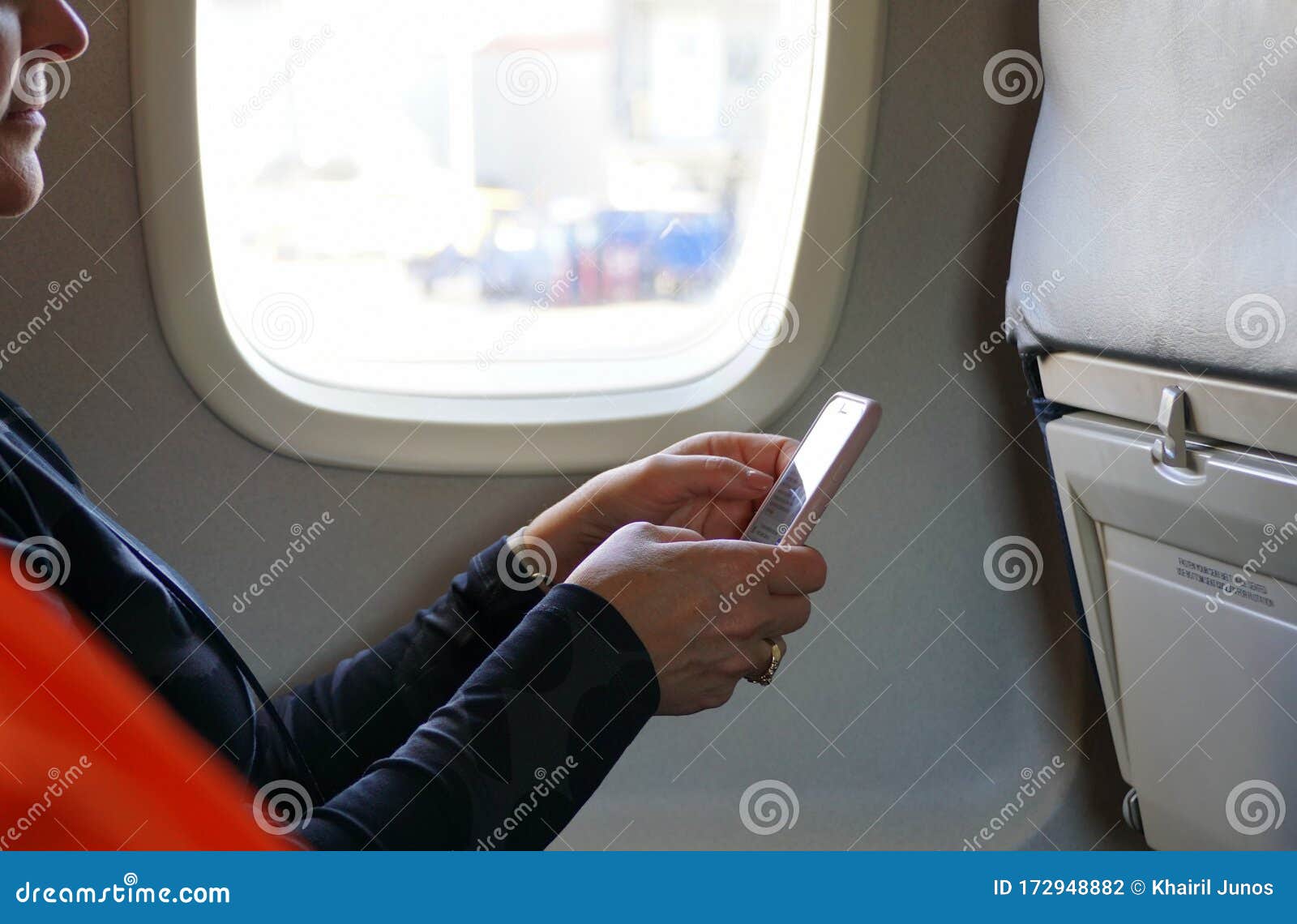 Passenger Using Their Mobile Phones While Waiting The Tram Luas At ...