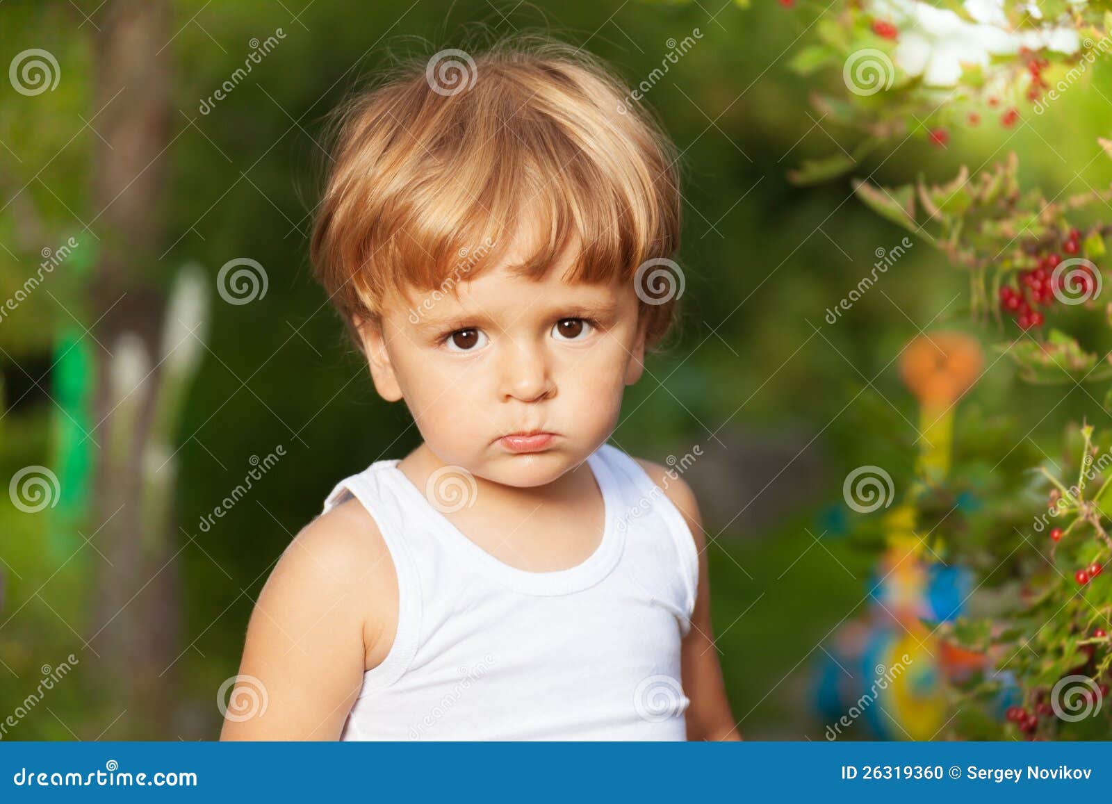 Moody kid in the garden stock photo. Image of cute, funny - 26319360