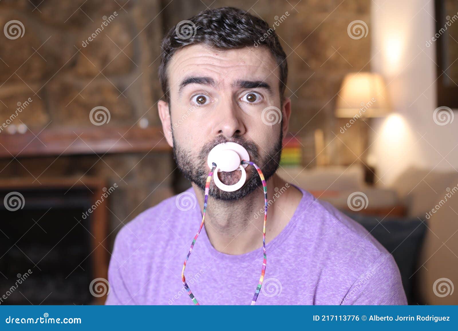 Moody man using a pacifier stock photo. Image of lifestyle - 217113776