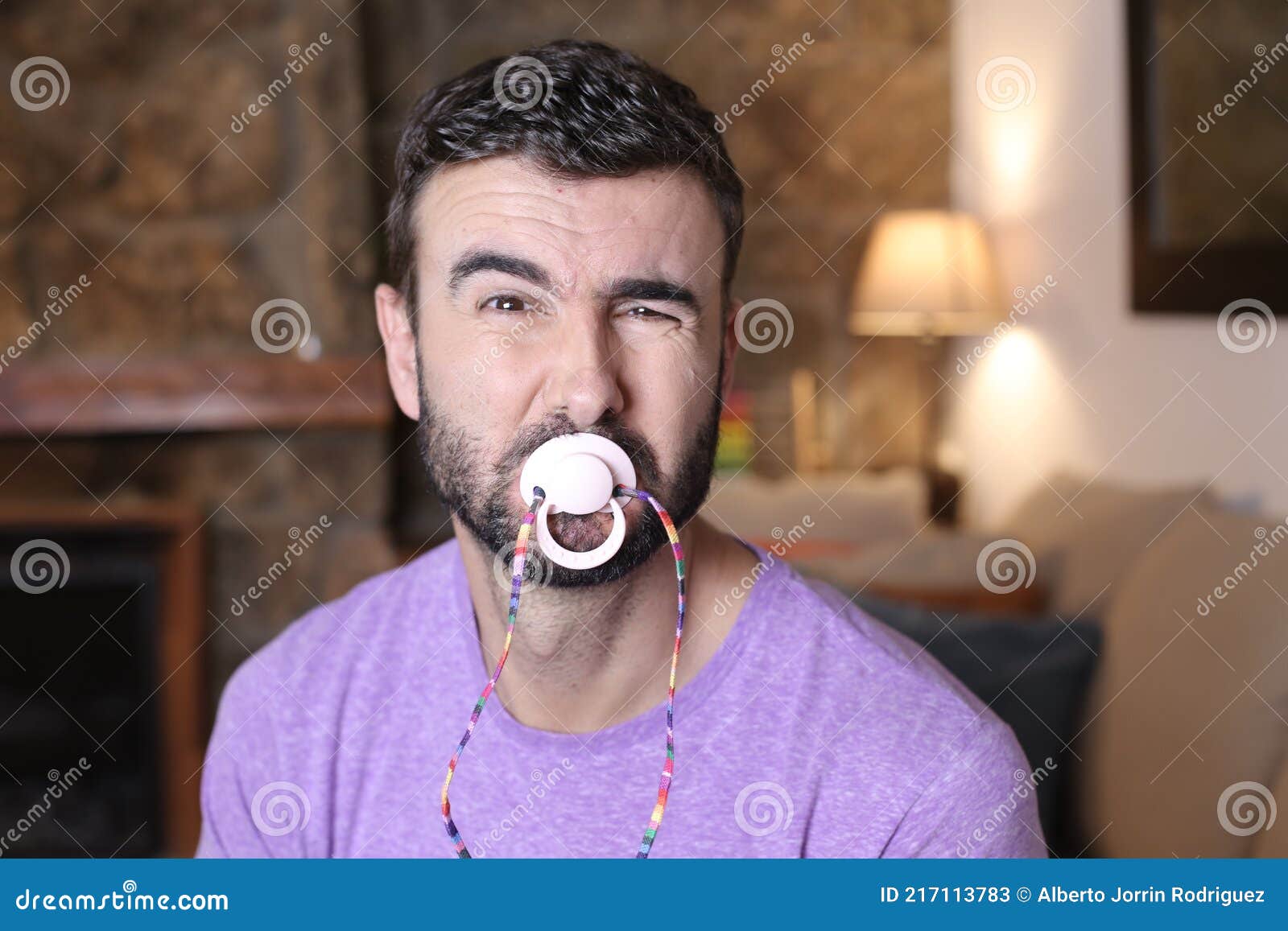 Moody man using a pacifier stock image. Image of mouth - 217113783