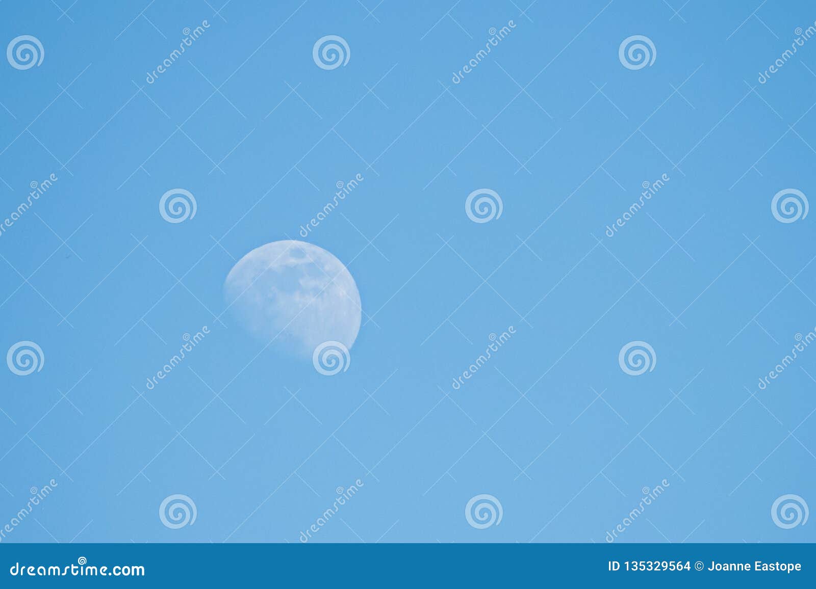Moon in daylight sky stock photo. Image of lunar, clear - 135329564