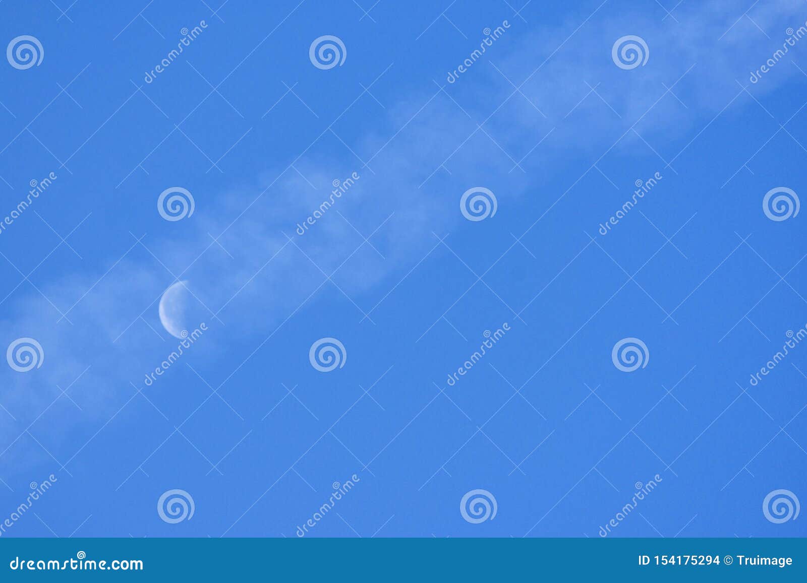 The moon in daylight sky stock photo. Image of colour - 154175294
