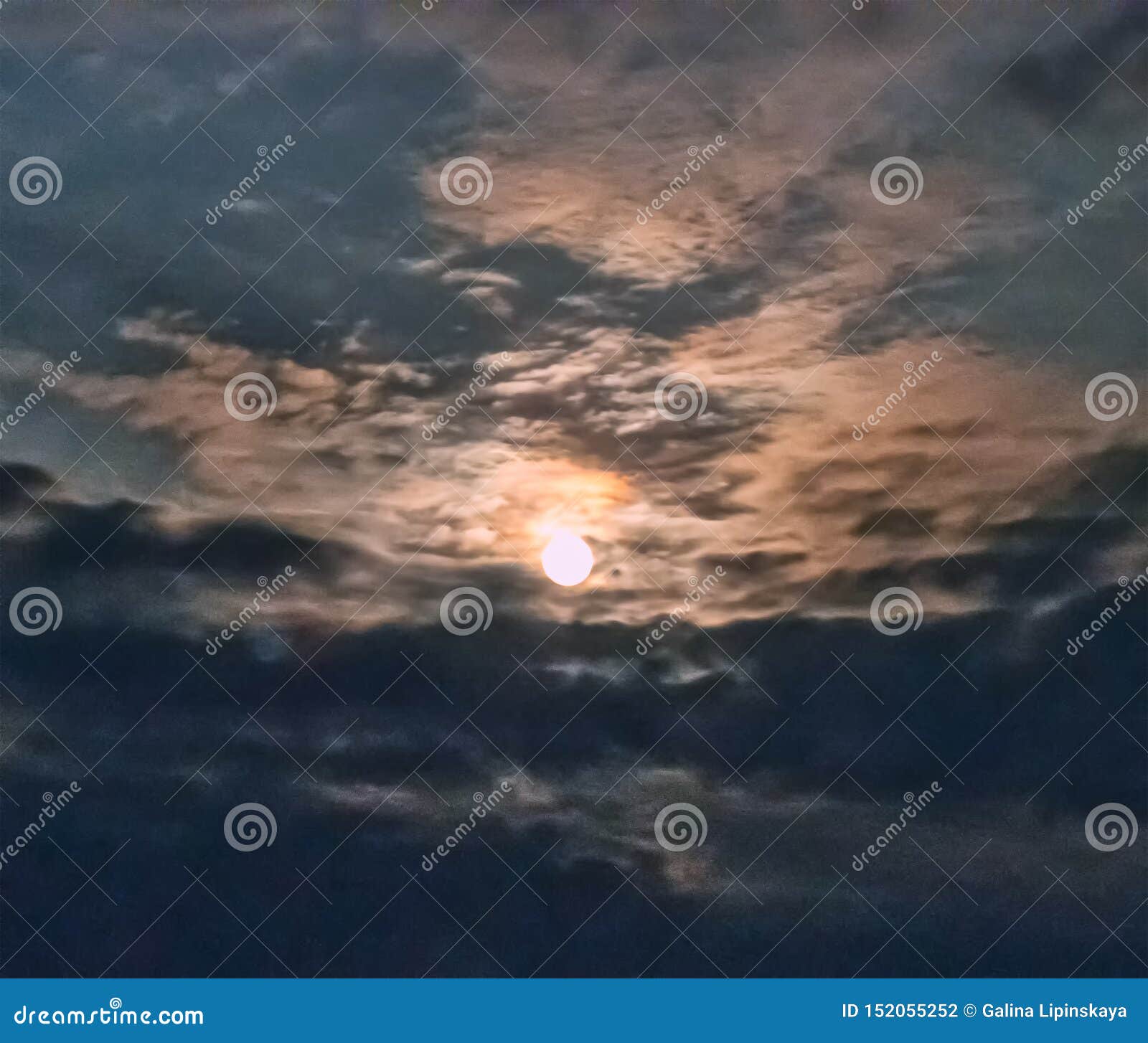 The Moon Looks through an Opening in the Clouds Stock Photo - Image of ...