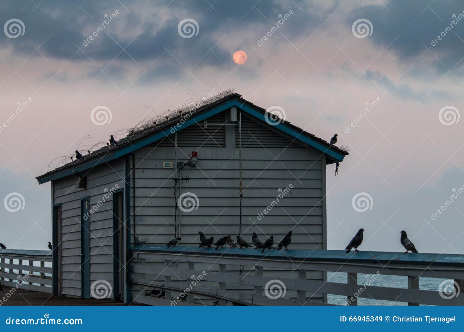 Moon over pier shack stock image. Image of glow, monochrome - 66945349