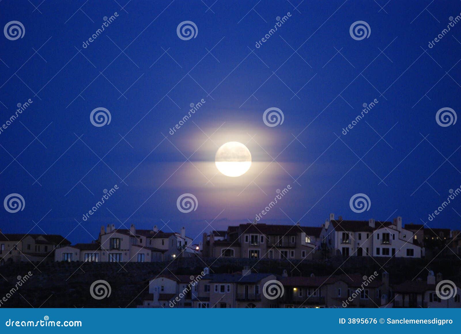 Moon over roof tops stock photo. Image of neighborhood - 3895676