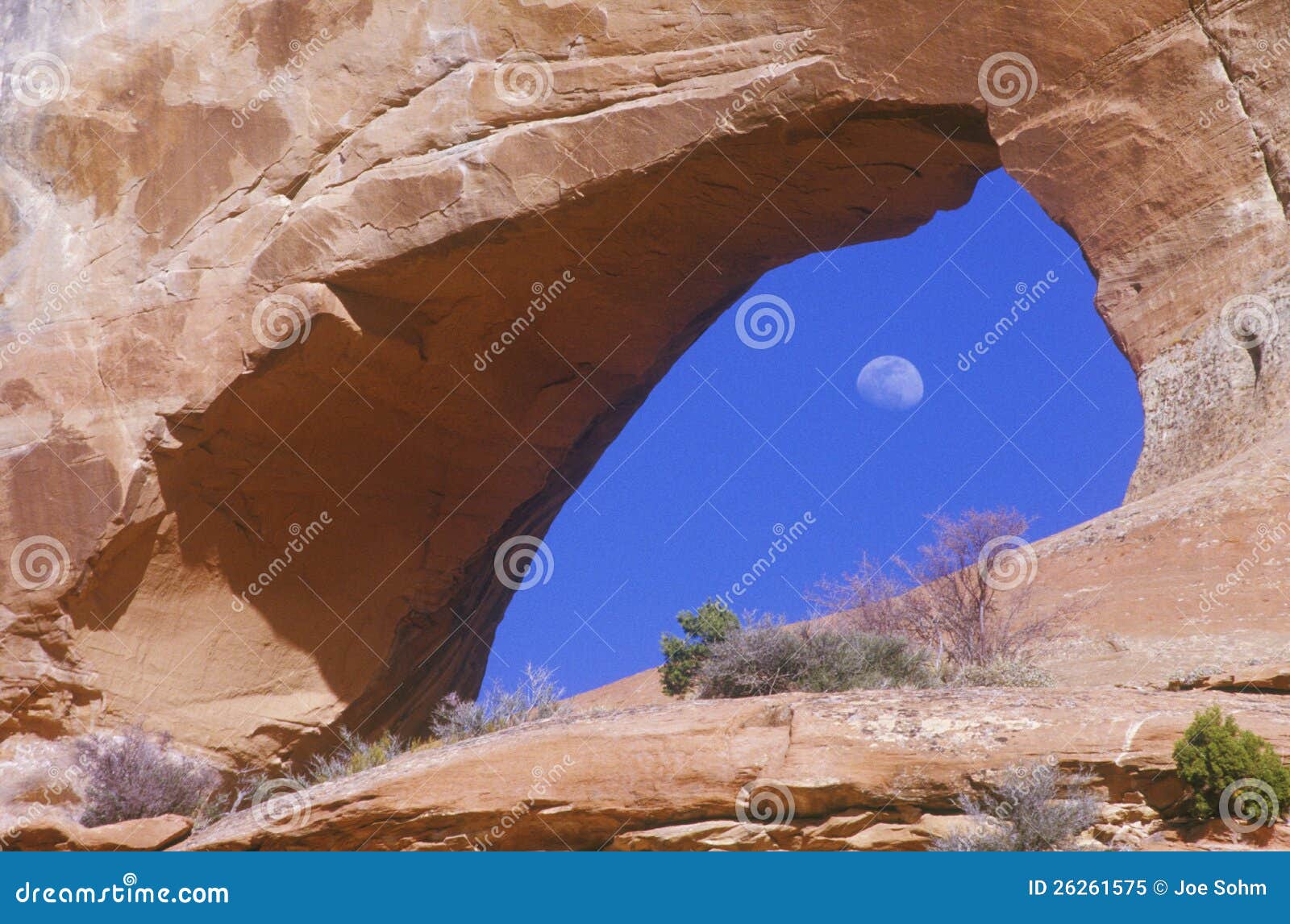 Moon Seen through Rock Formation Stock Image - Image of desert, western ...