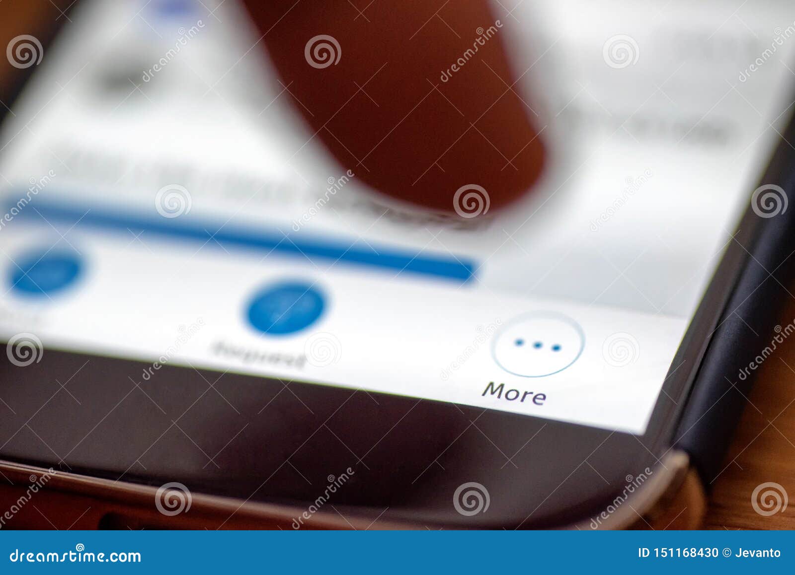 More Button on Smartphone Screen Closeup with Human Finger Pointing To ...