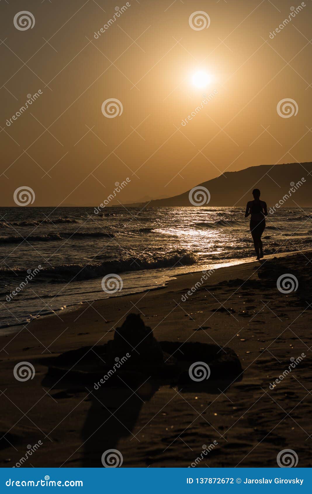 Morning beach and runner stock photo. Image of dark - 137872672