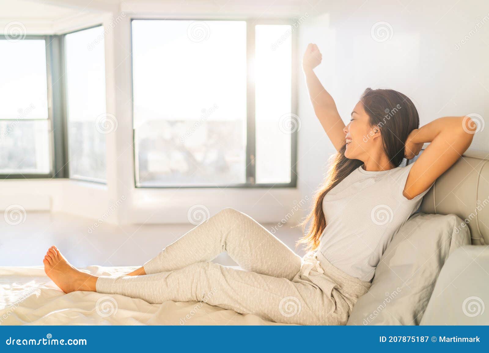 Morning Woman Waking Up Stretching In Bed In Sunshine Sunrise Early