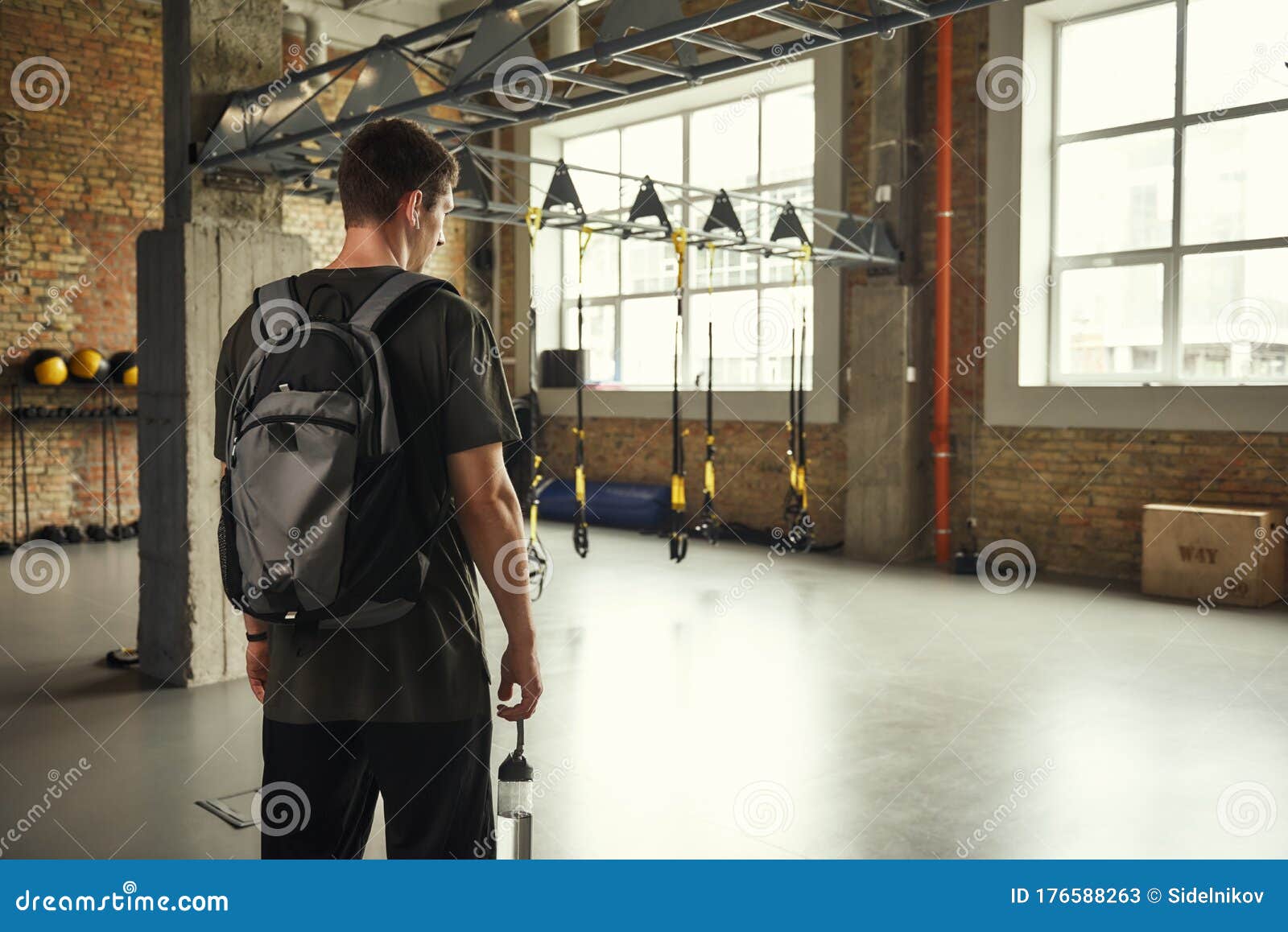 Morning Workout. Back View of Young Man with Backpack Standing in Empty ...