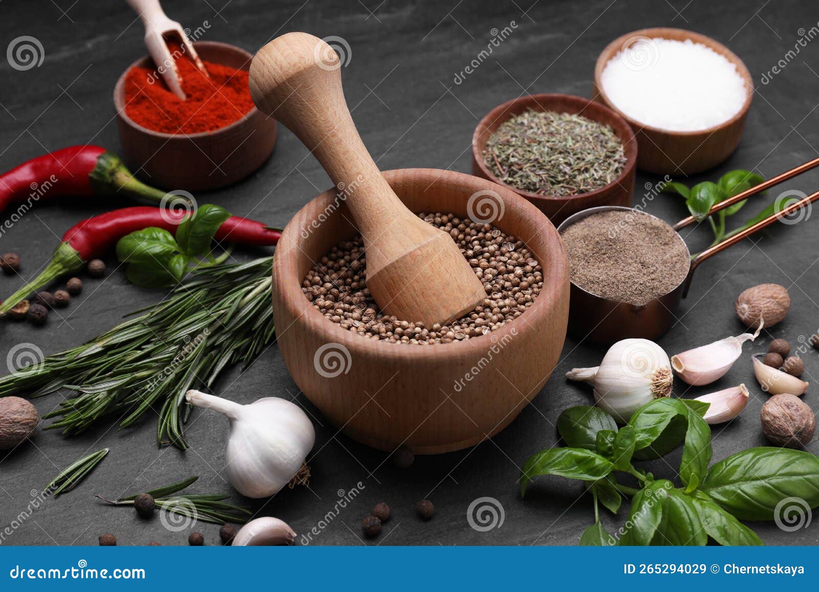 Mortar with Pestle and Different Spices on Black Table Stock Image ...